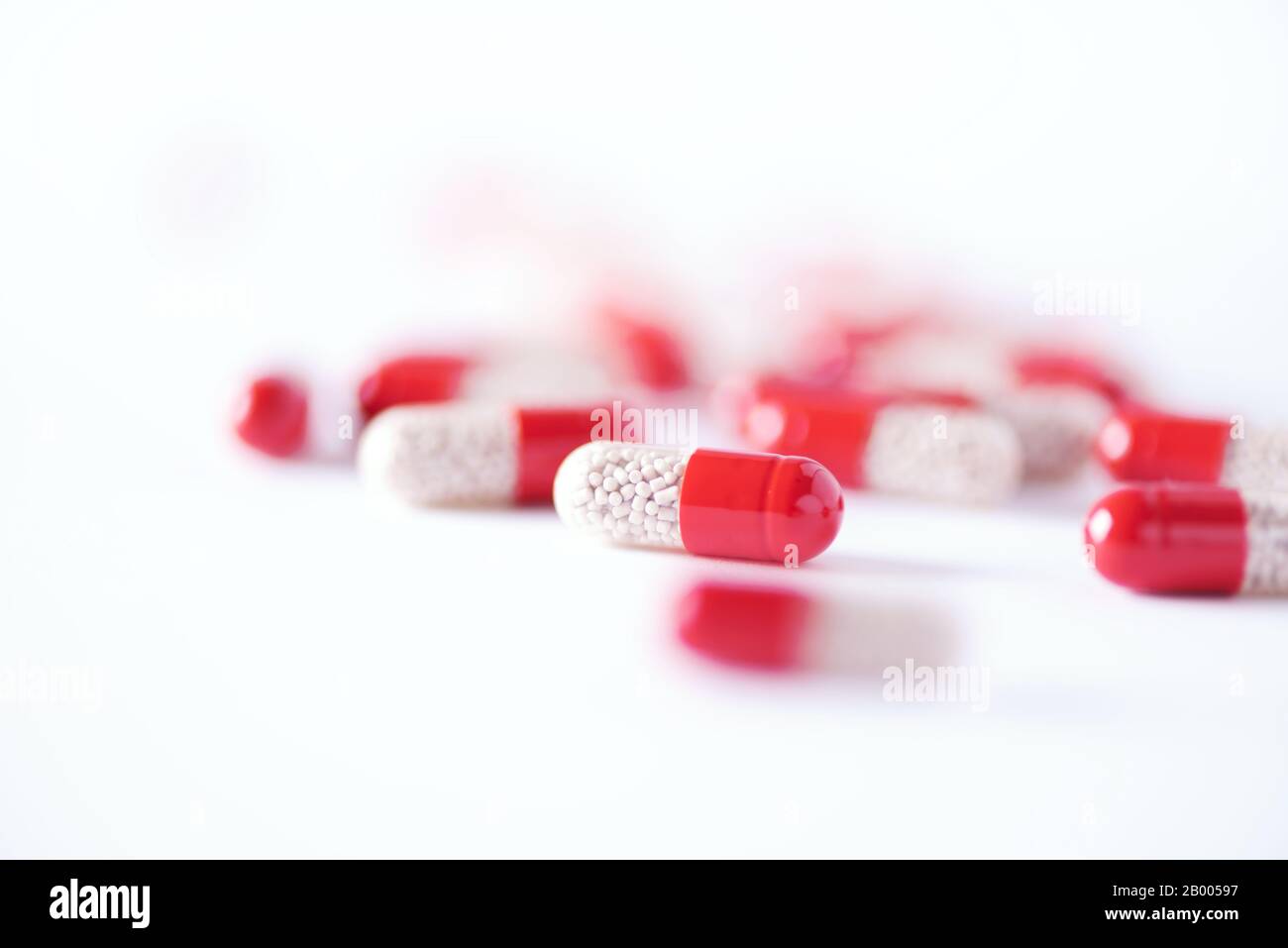 Enzyme capsules on white background. Red pills. Copy space Stock Photo ...