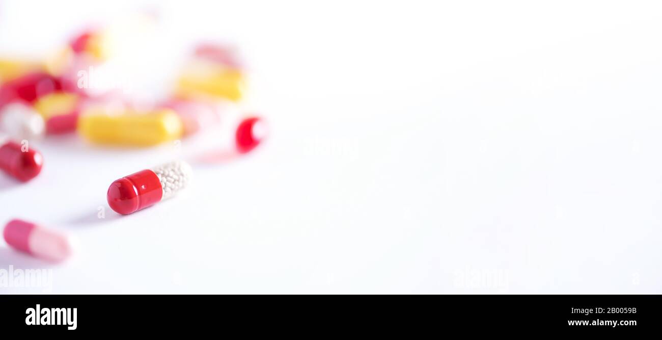 Multicolor tablets and pills over white background with copy space ...