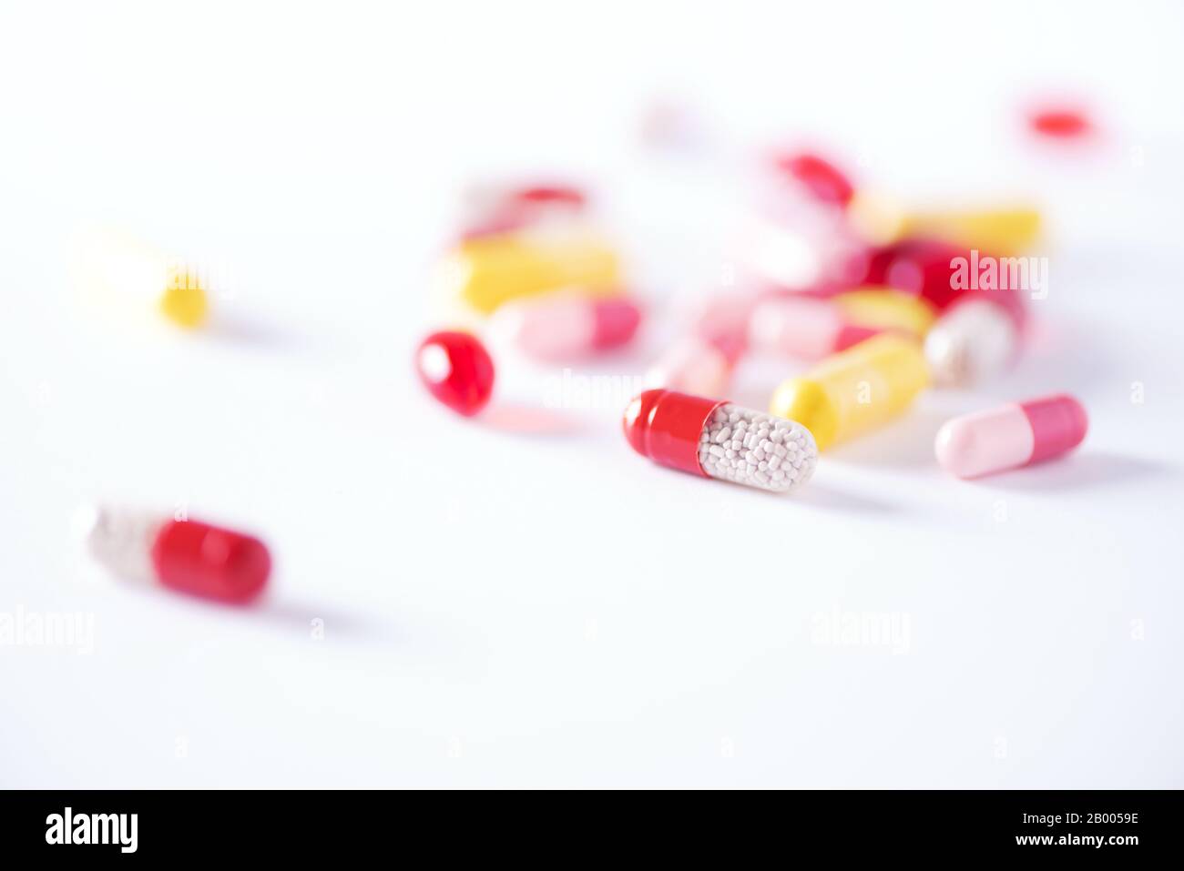 Multicolor tablets and pills over white background with copy space ...