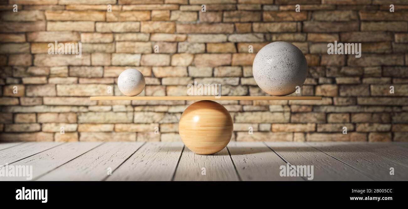 wooden scale balancing one big ball and one small ball in front of a ...