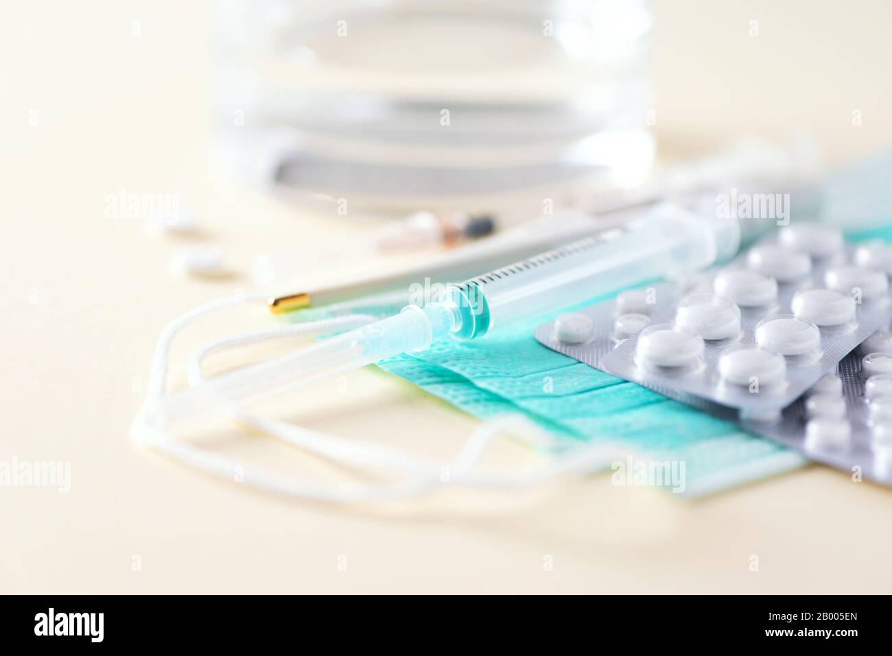 Concept of flu treatment - pills, capsules, thermometer, protective ...