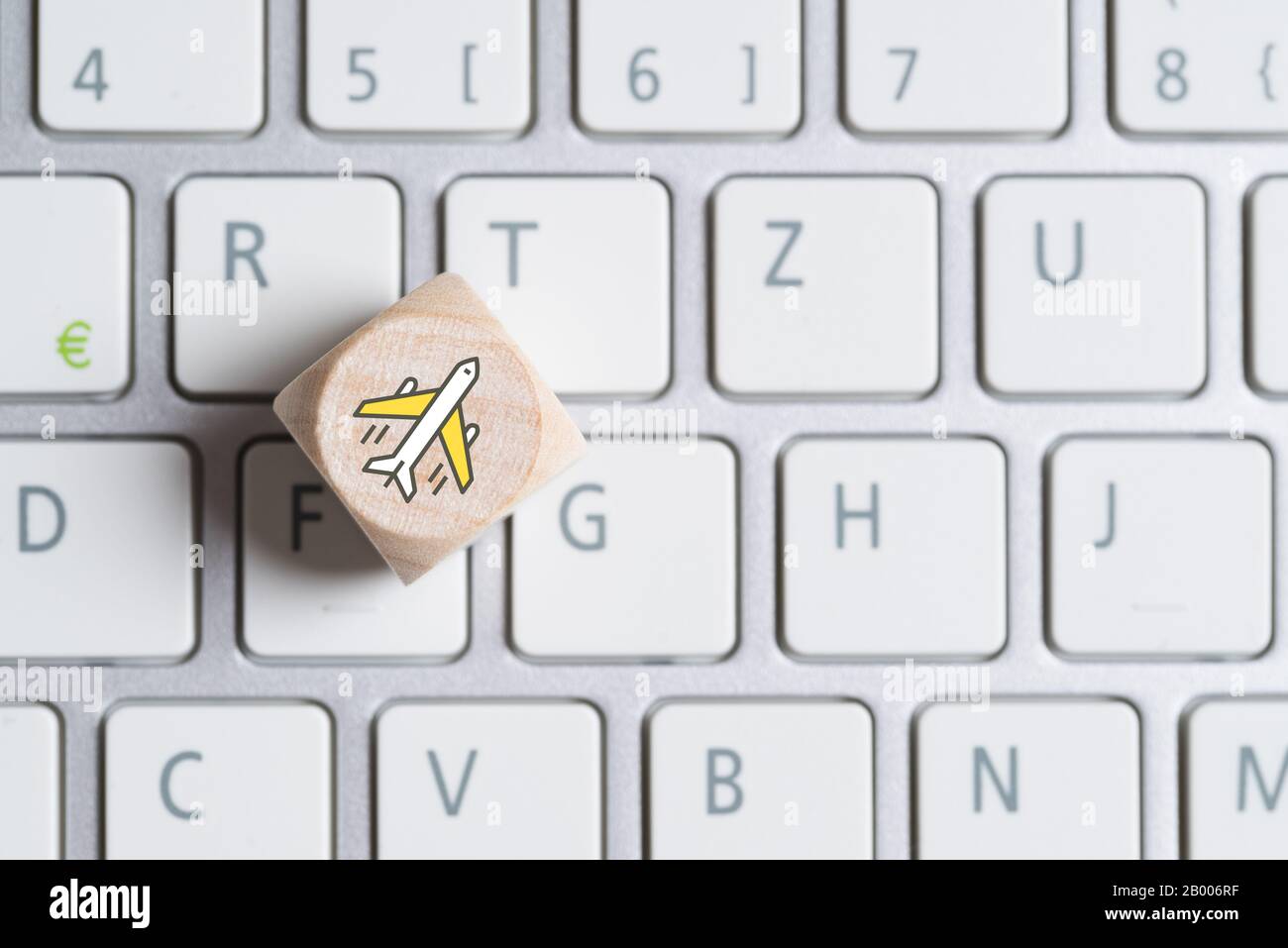 wooden cube with airplane symbol on a keyboard Stock Photo - Alamy