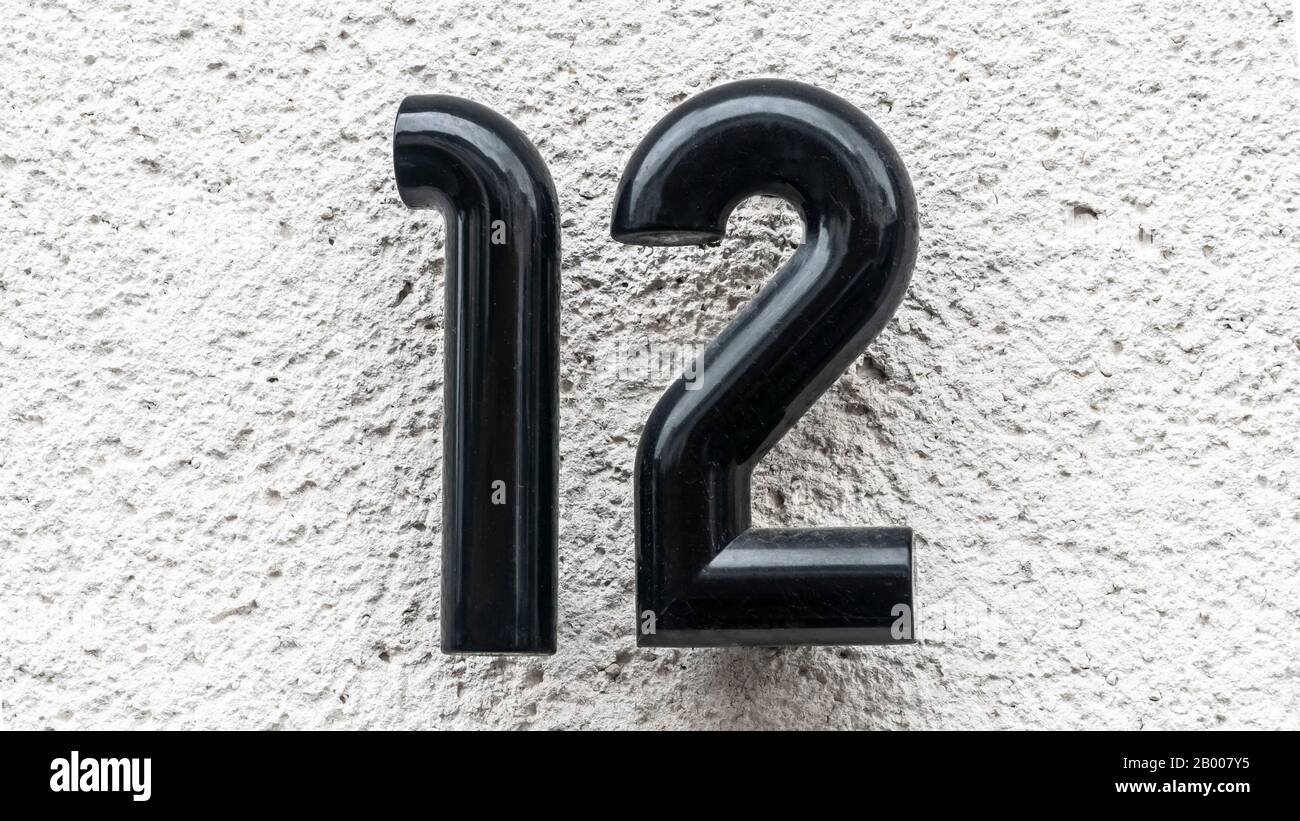 Black number Twelve on House Facade Stock Photo - Alamy