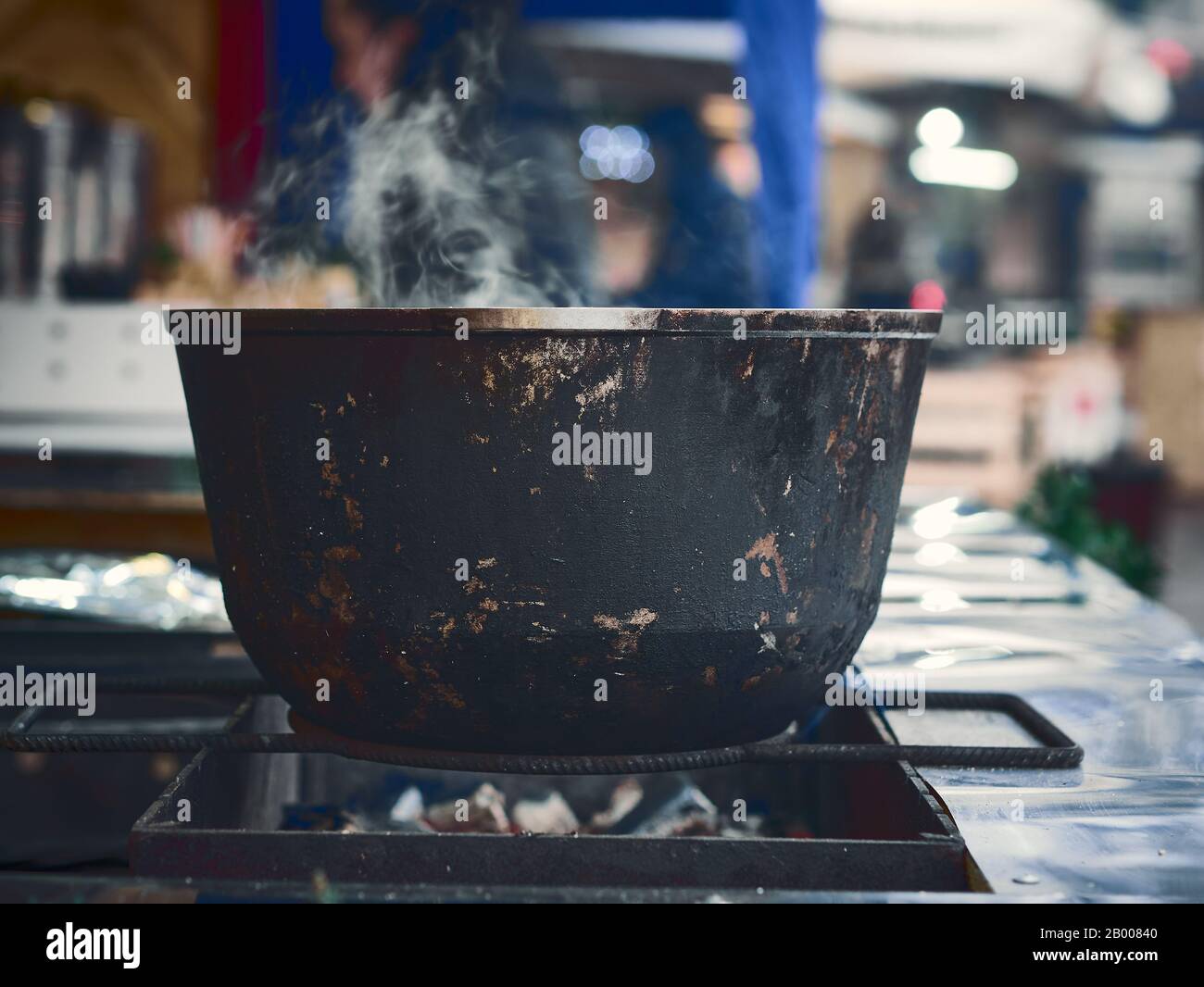 Large black iron cauldron cooking food during food festival in cold ...