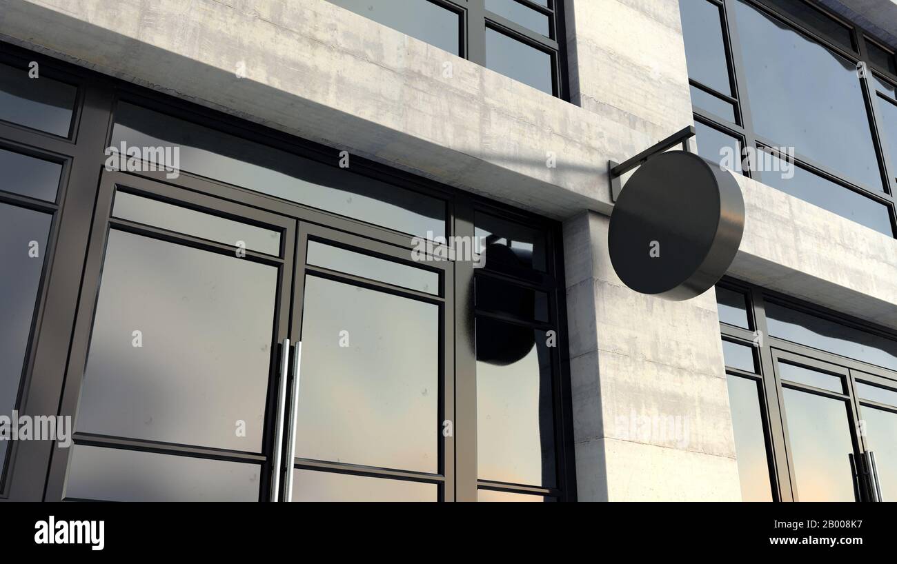 A round black sign mounted outside a generic unbranded shop facade on ...