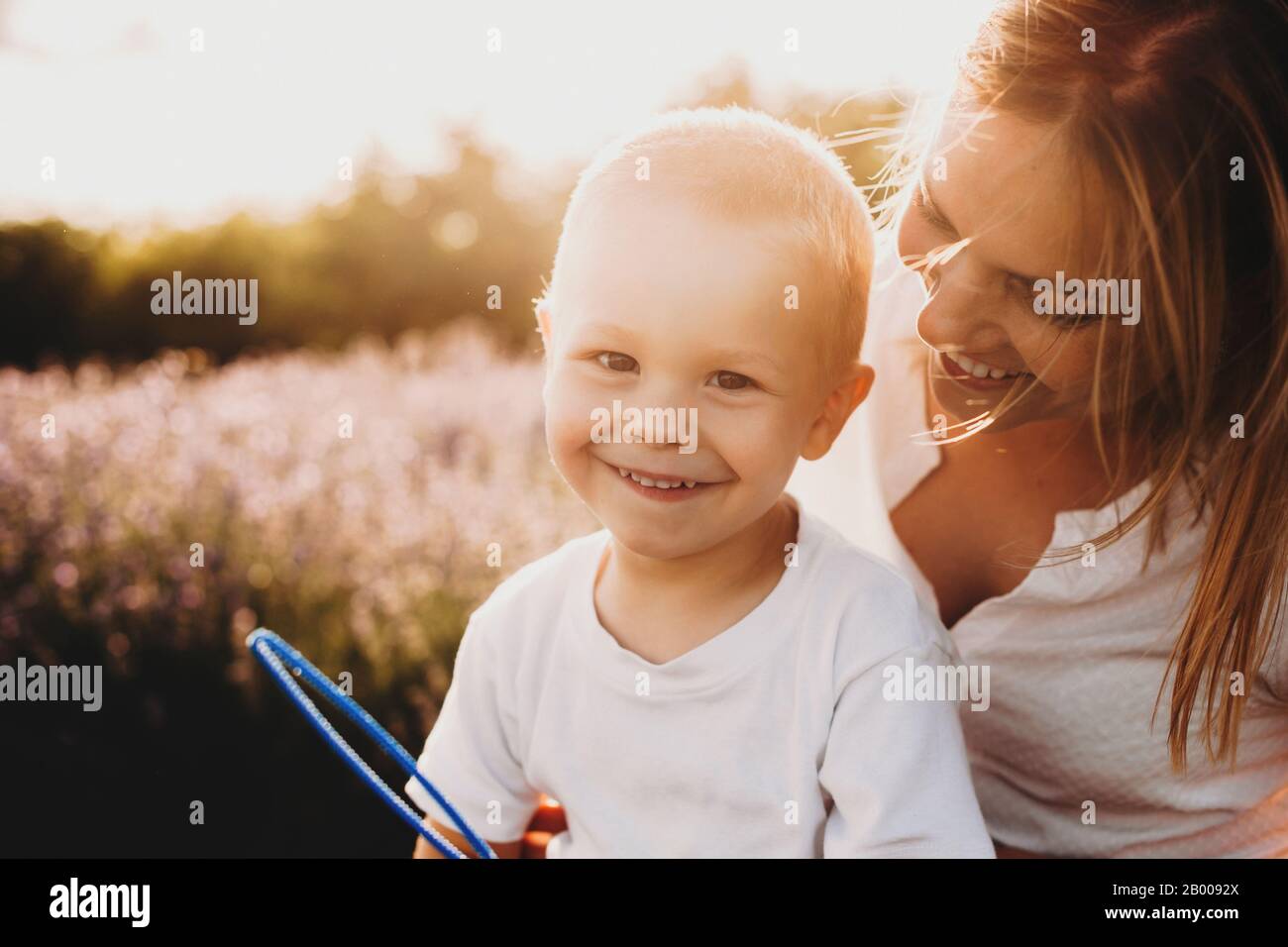 The picture of a small caucasian boy being held by his mother is ...