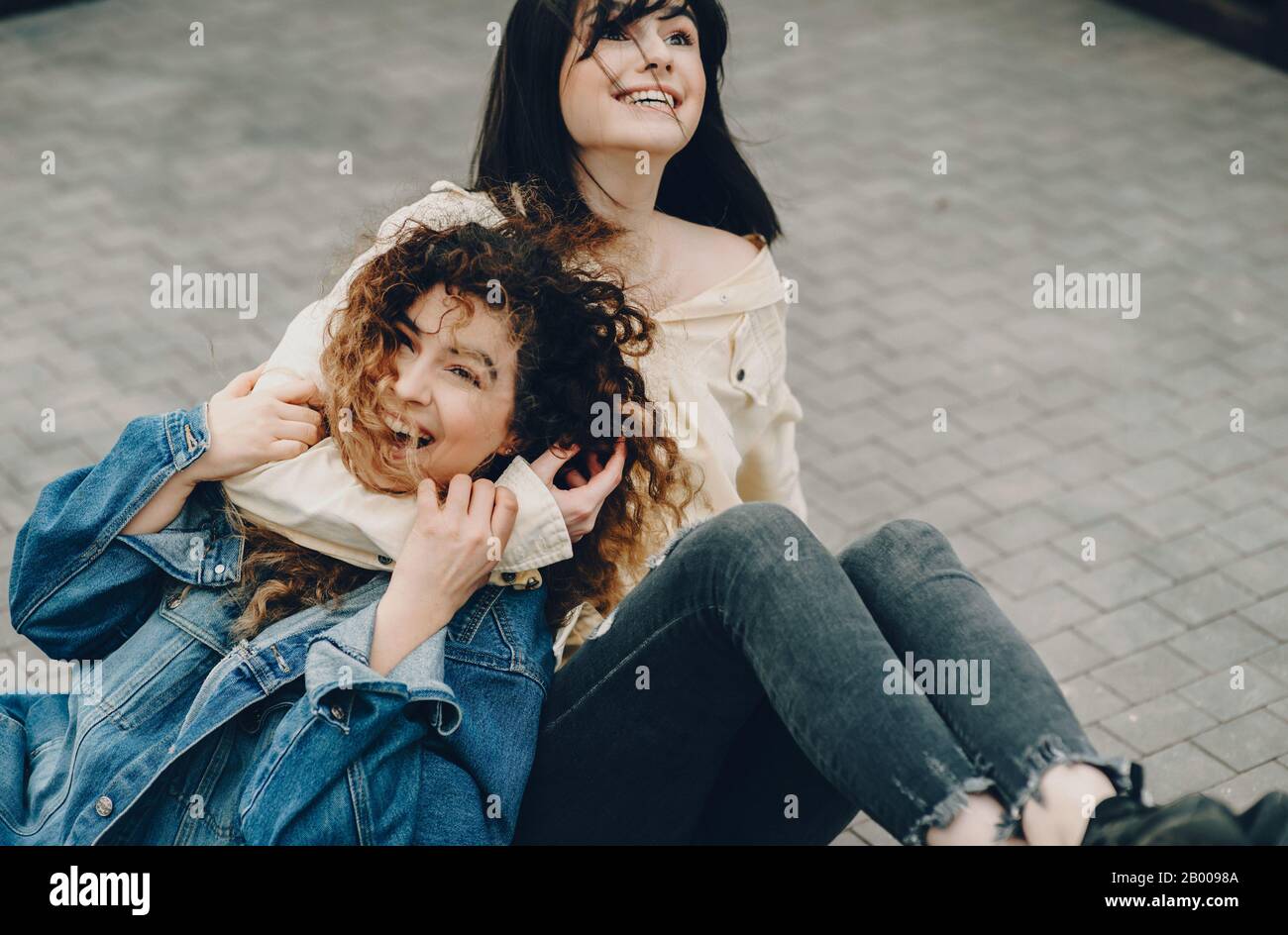 Two young charming girls playing joyfully after a long time without ...