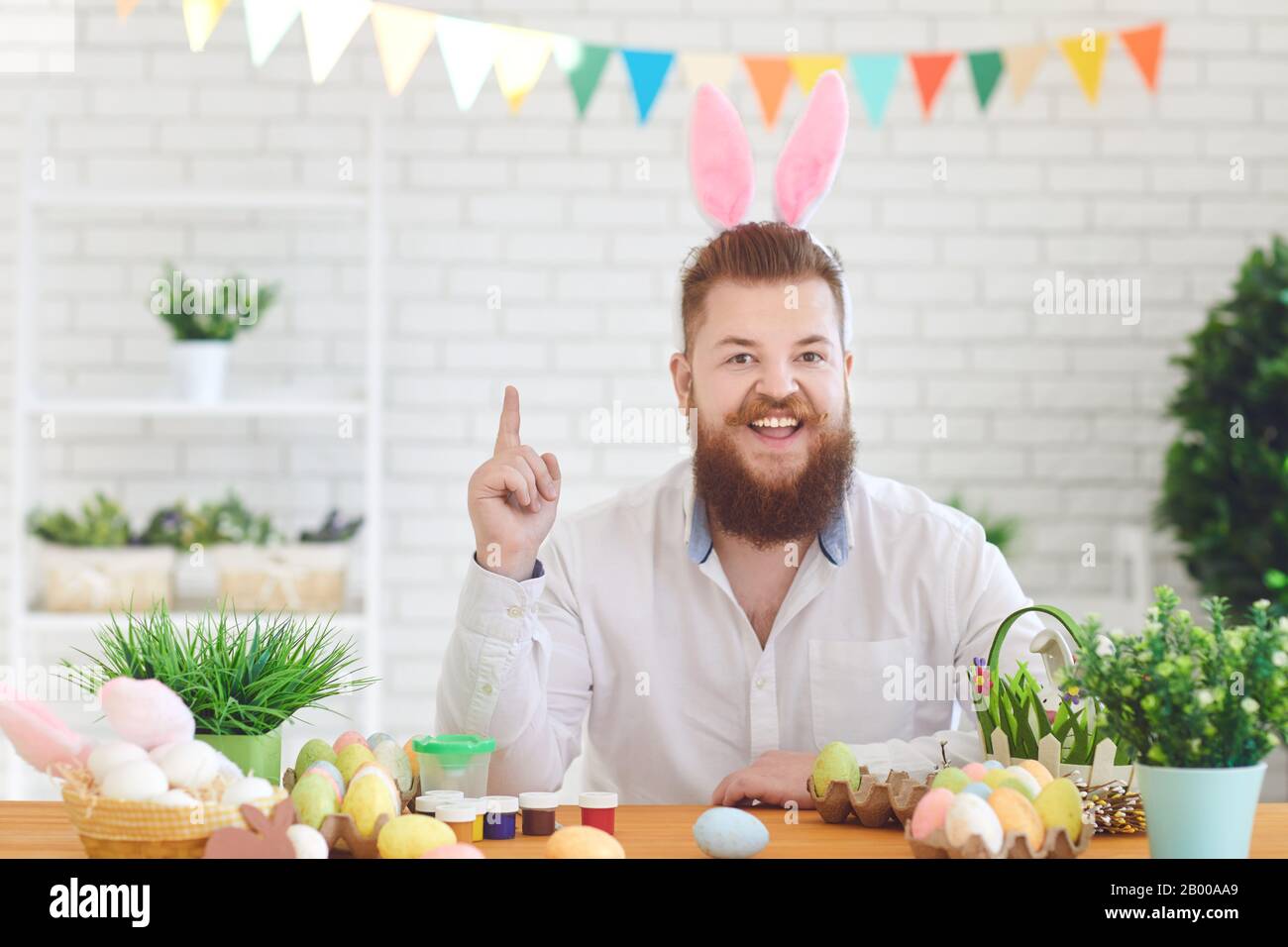 Happy easter. Funny male bearded man smiling gets out pointing his ...