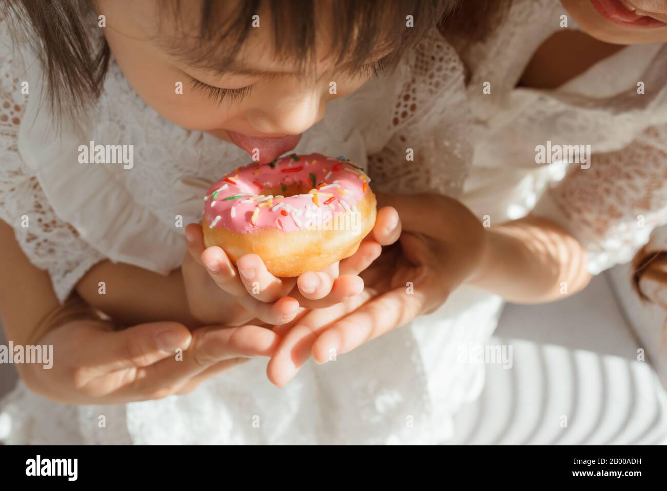 Girl eating donut hi-res stock photography and images - Alamy