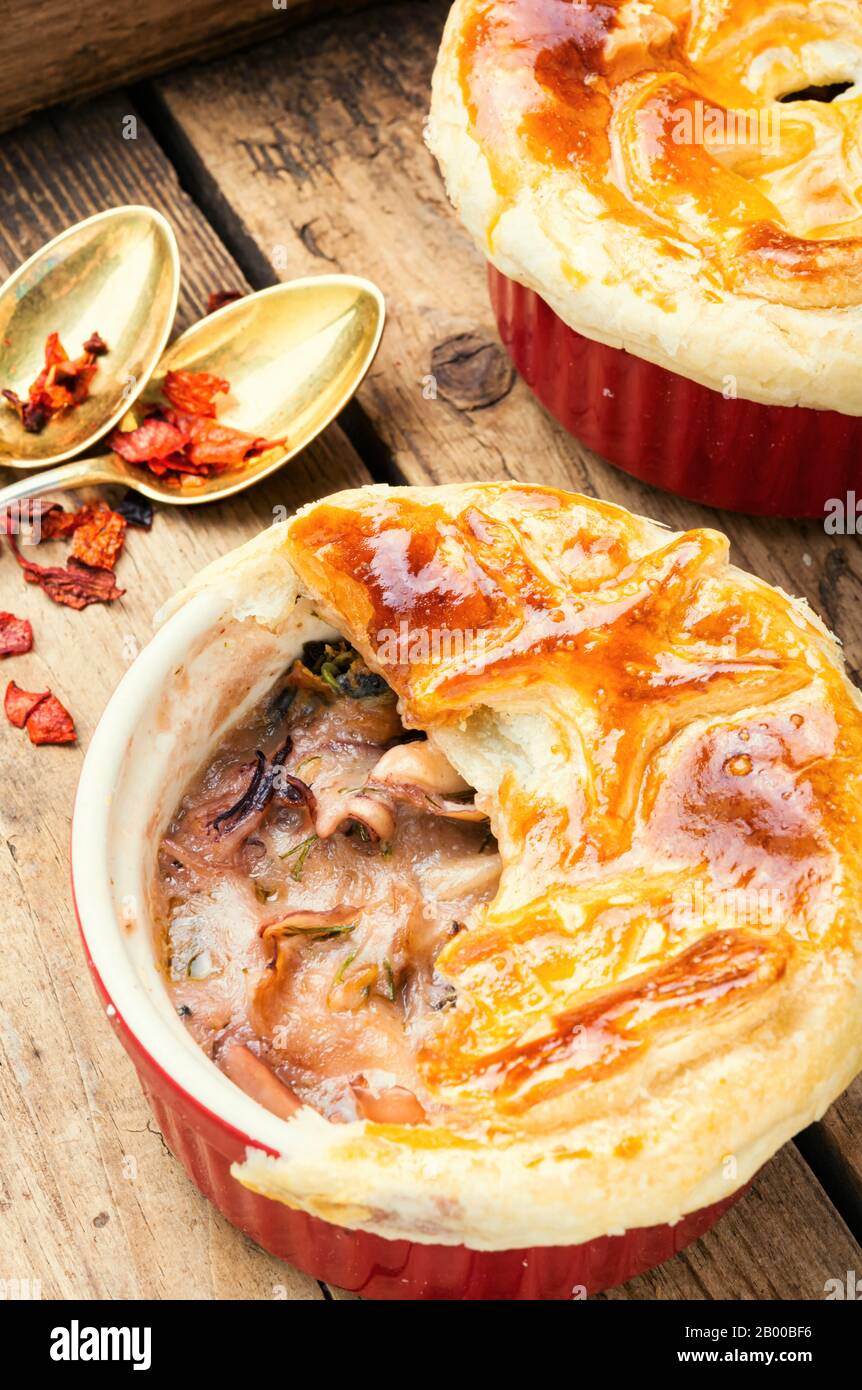 Squid and seafood soup with bread cap.Seafood julienne Stock Photo - Alamy
