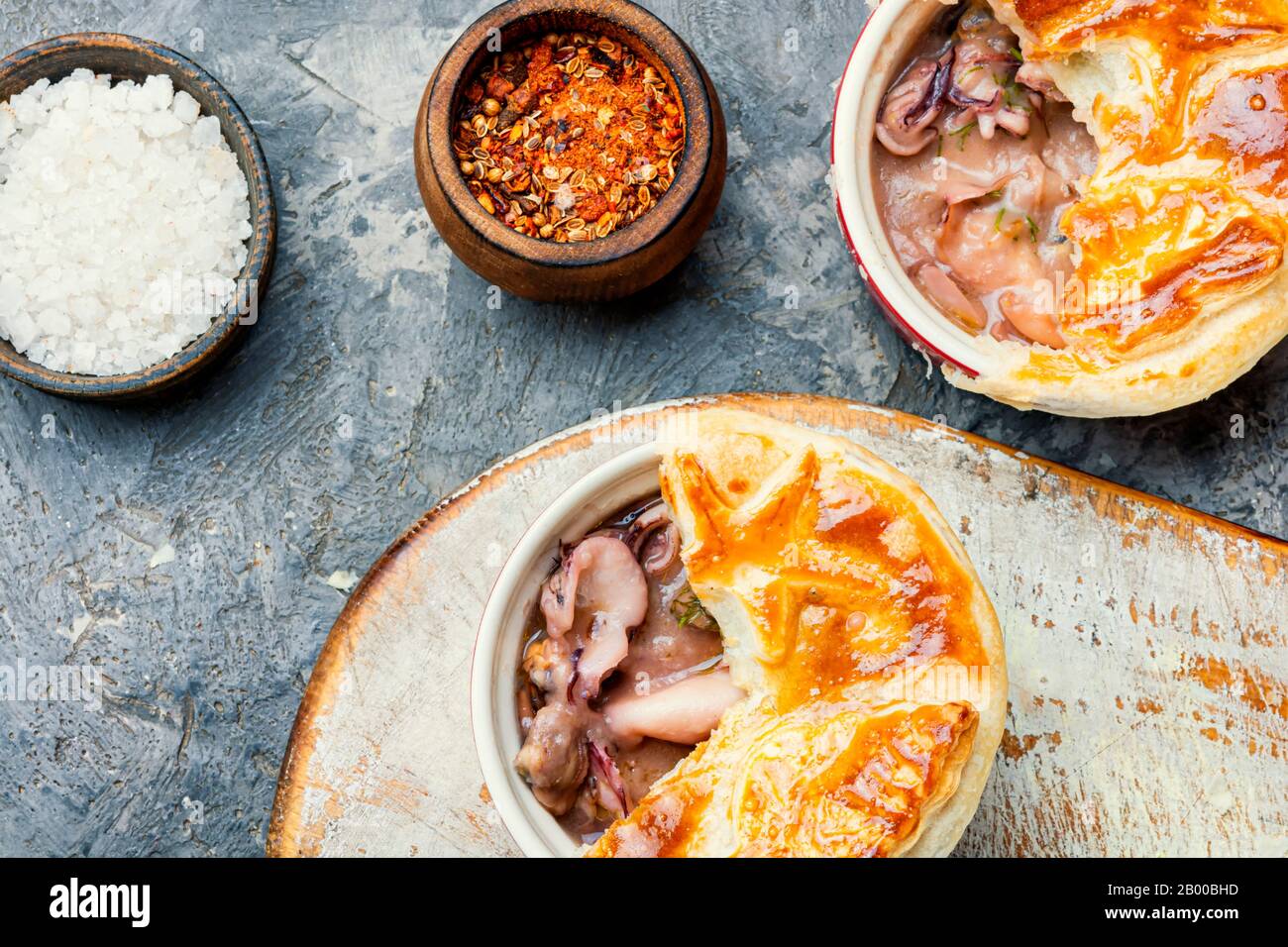 Baked seafood with bread cap.Squid and mussel julienne.Cream seafood ...