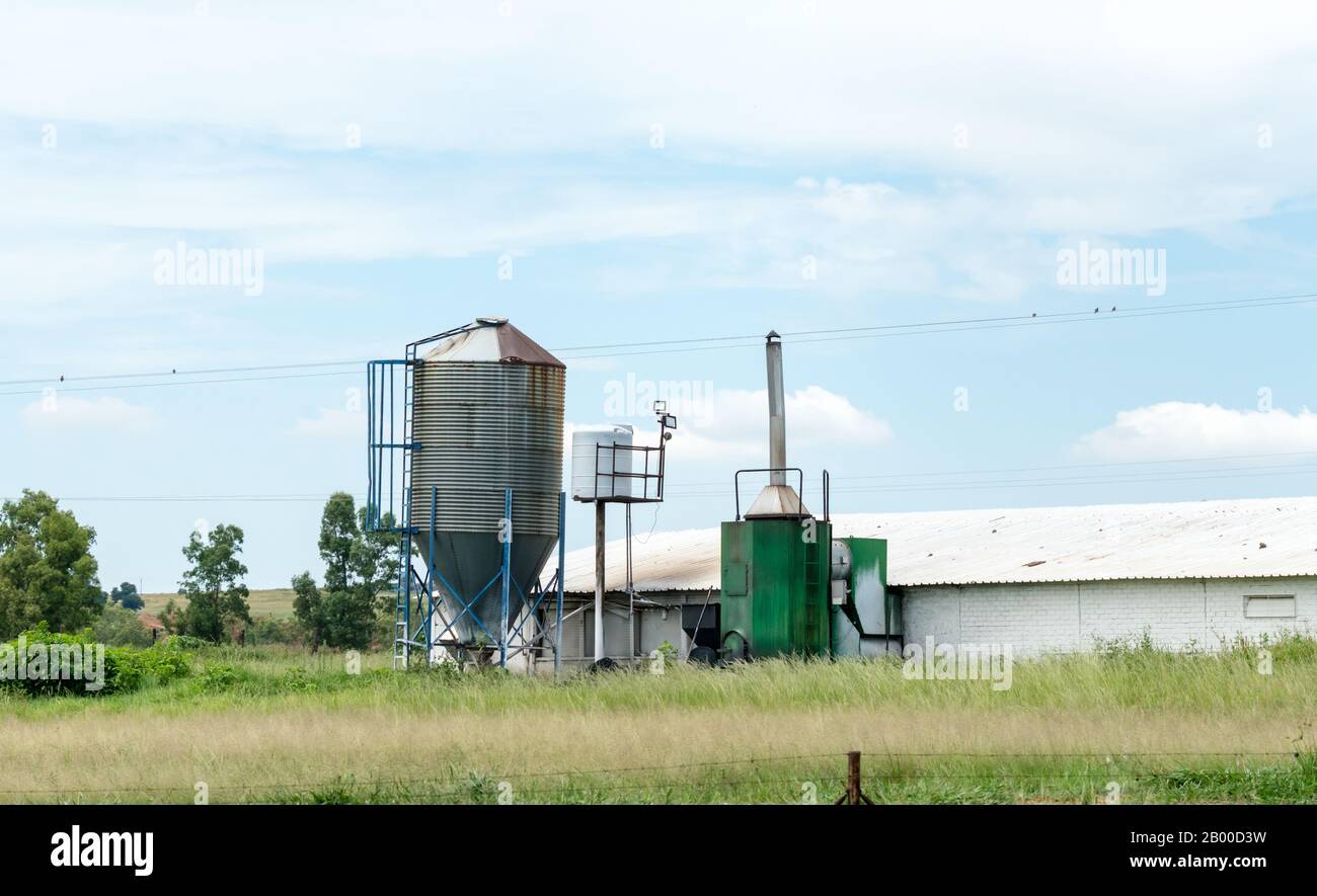 agricultural machinery and equipment outside a barn or building on a ...