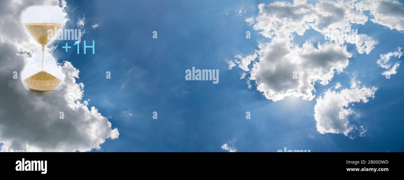 Daylight Saving Time (DST). Blue sky with white clouds and clock. Turn ...