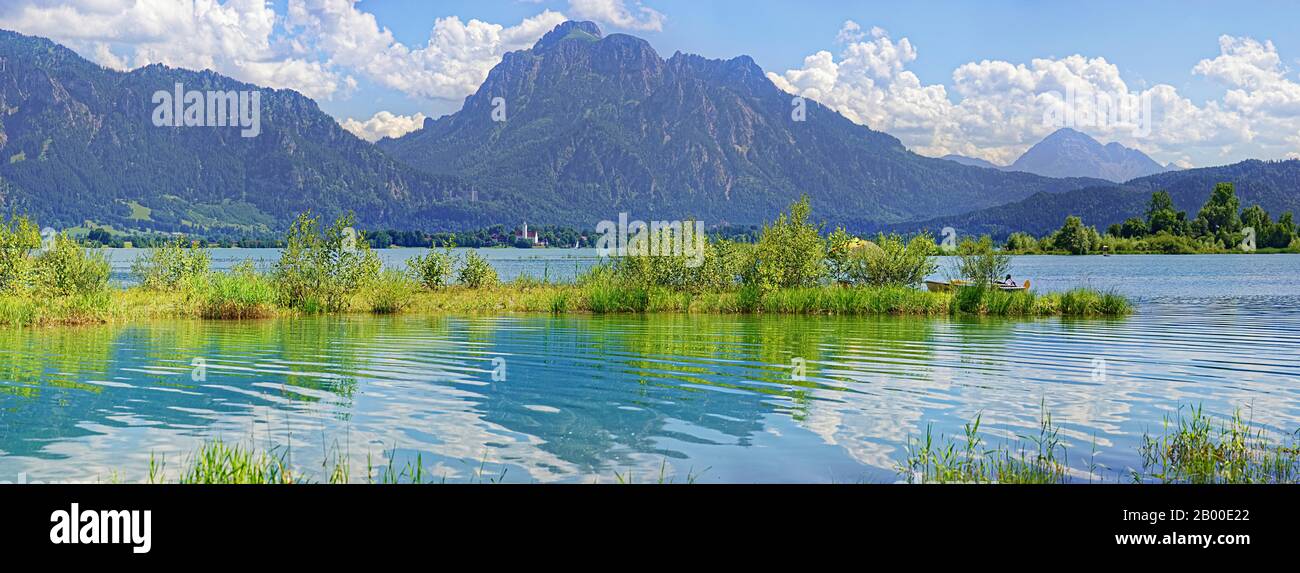 Bathing beach at lake forggensee with ammergau alps hi-res stock ...