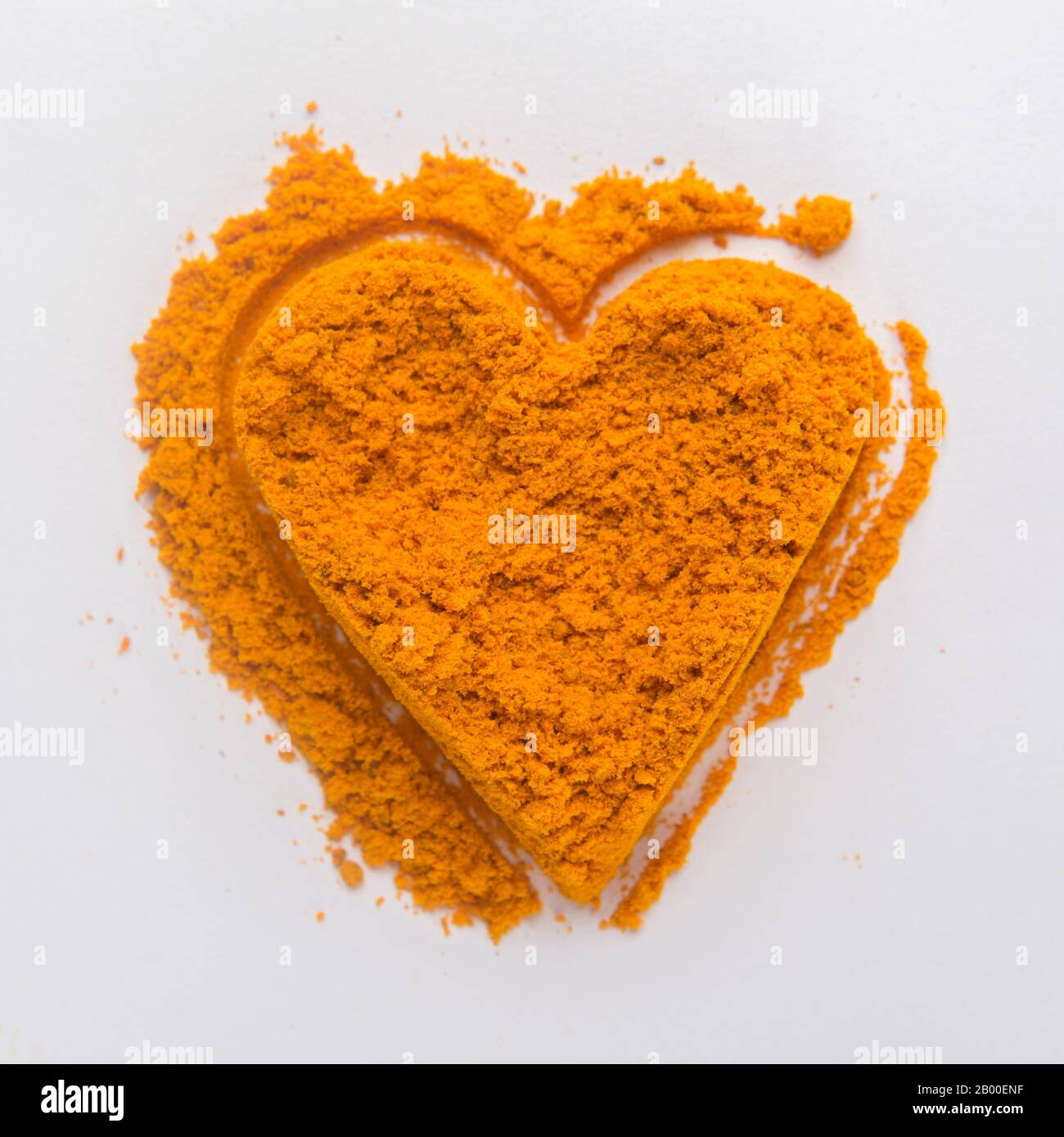 Turmeric powder in the shape of a heart Isolated on white Stock Photo ...