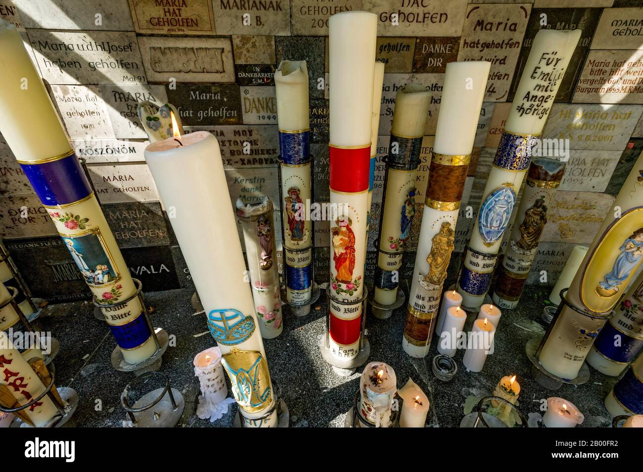 Sacrificial candles, votive candles, grotto of Mary in the forest ...