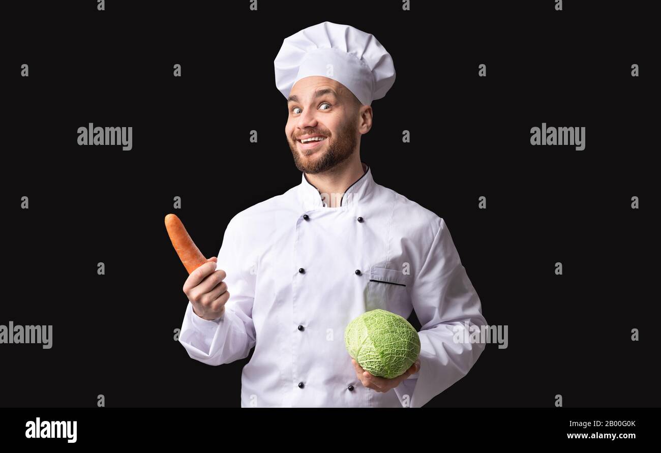 Funny Chef Guy Holding Carrot And Cabbage Posing, Black Background ...