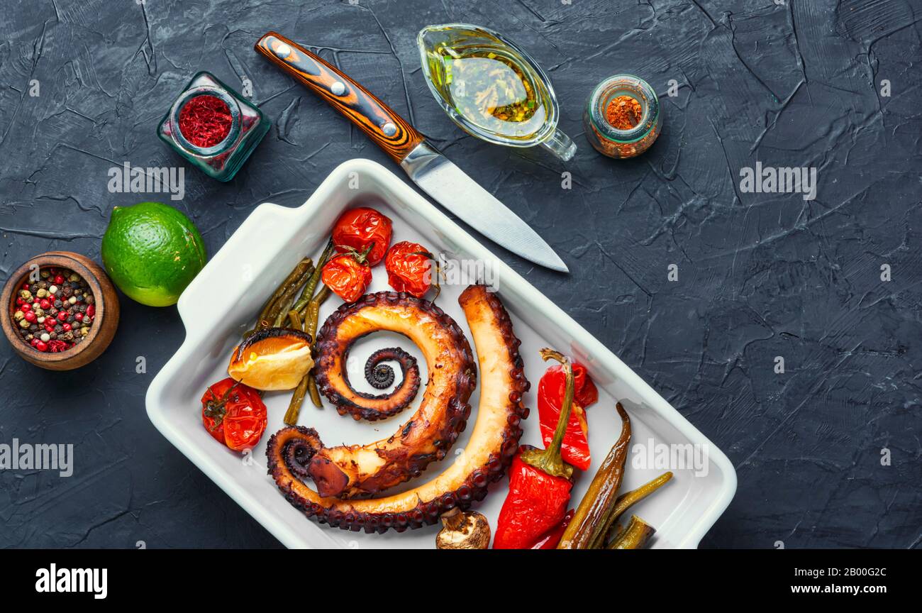 Grilled octopus with roasted vegetables in baking dish.Seafood Stock ...