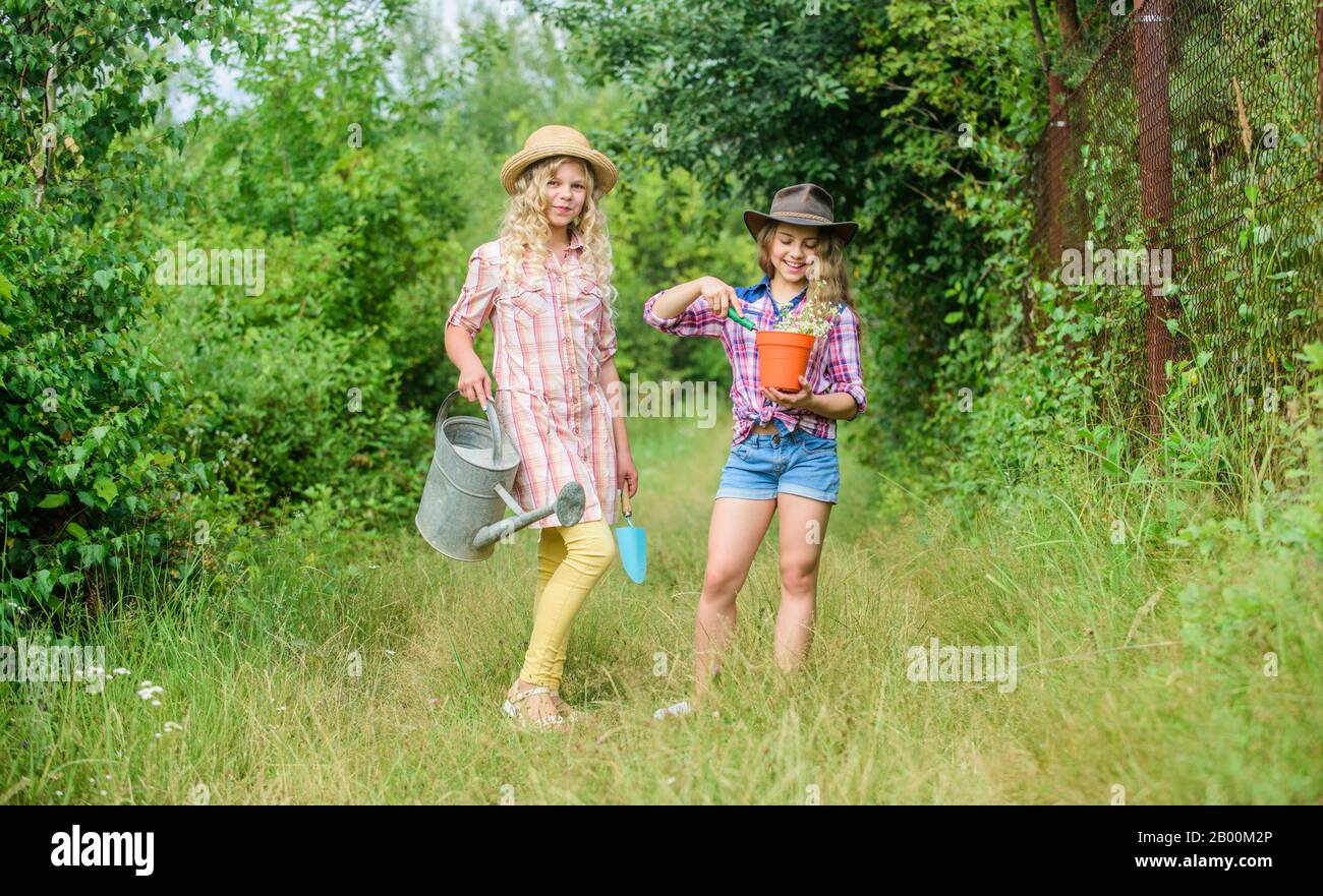 Kids having fun at farm. Eco farming concept. Planting and watering ...