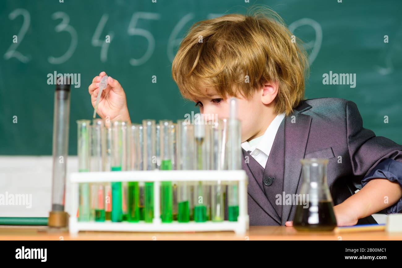 science experiments in lab. Little boy is making science experiments ...