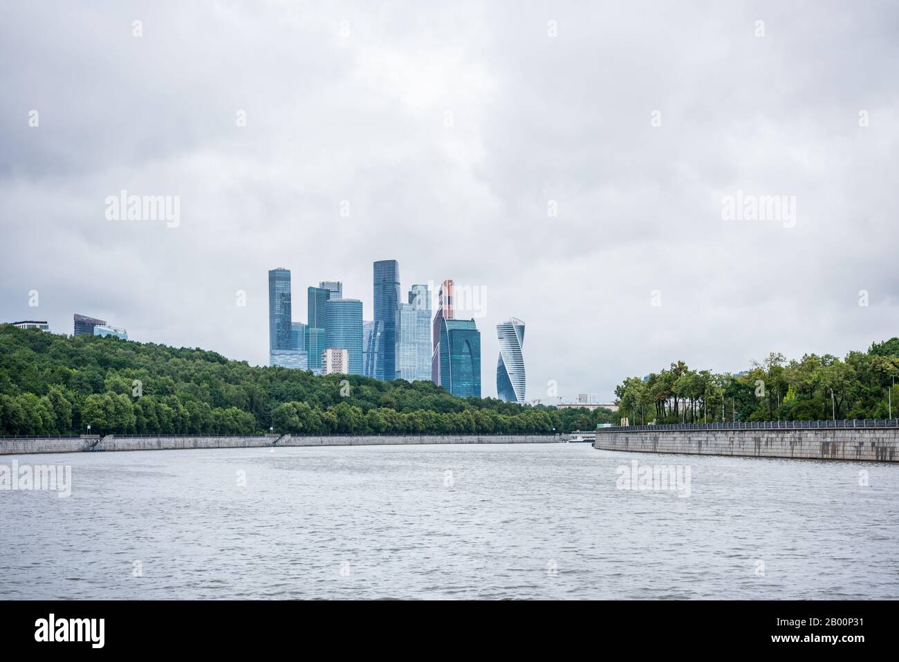 Modern international business center buildings and green forest at ...