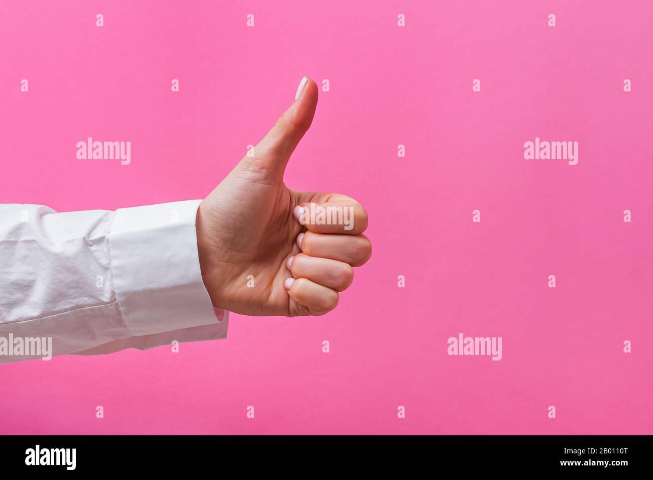 Woman's hand showing sign thumb up Stock Photo - Alamy