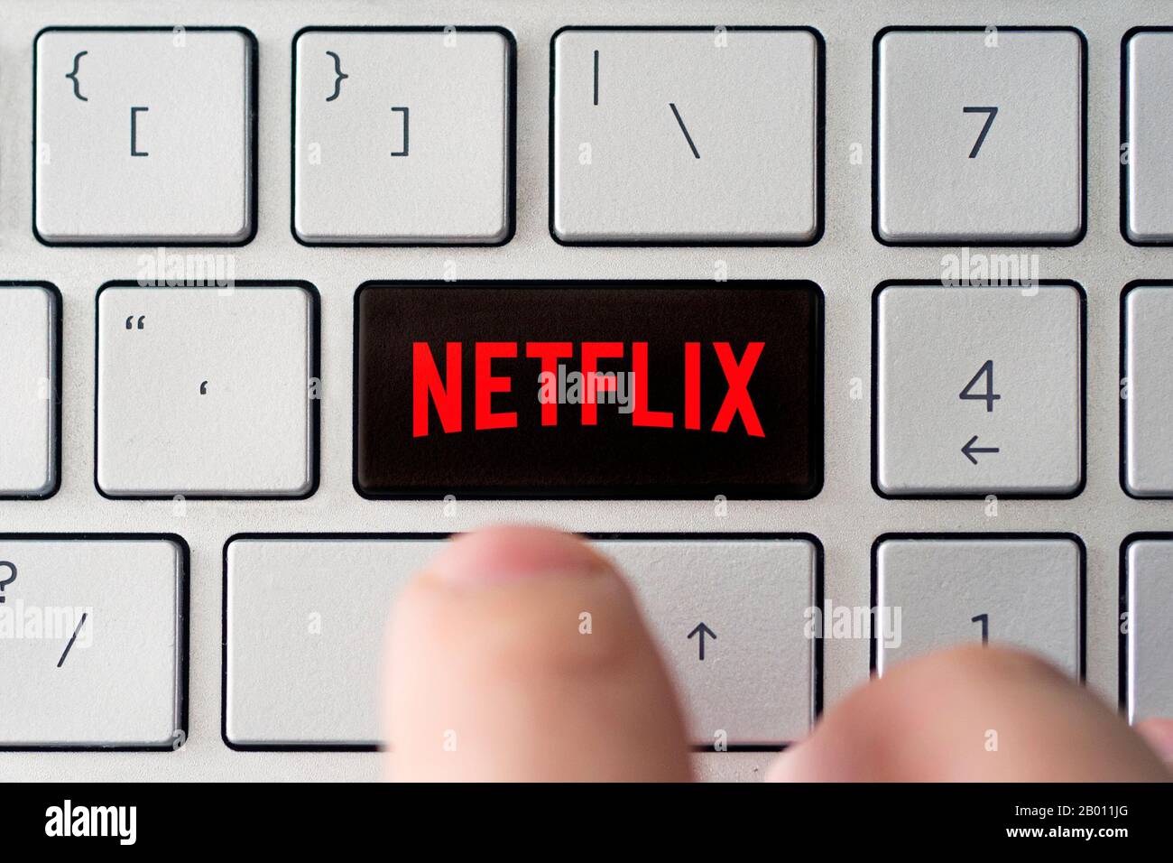 Dedicated Netflix key on computer keyboard, concept picture of global ...