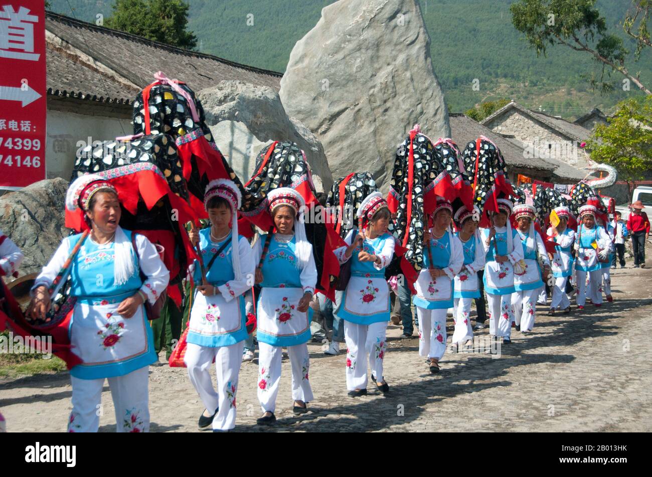 China: Bai on their way to the Bai music and dance festival at Santa Si ...