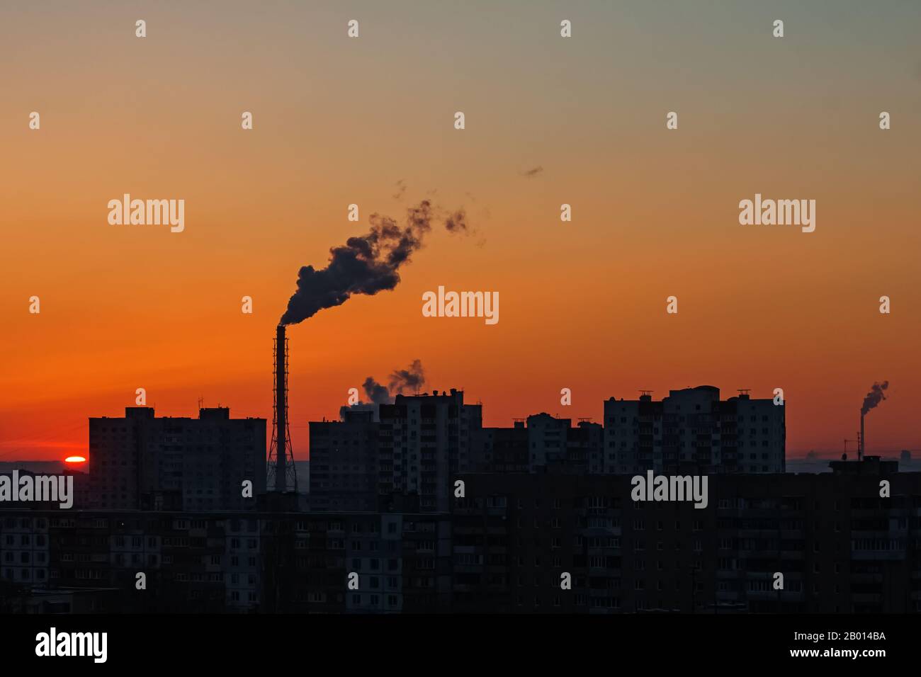 Yellow sunset over industrial landscape with factory chimneys and pipes ...