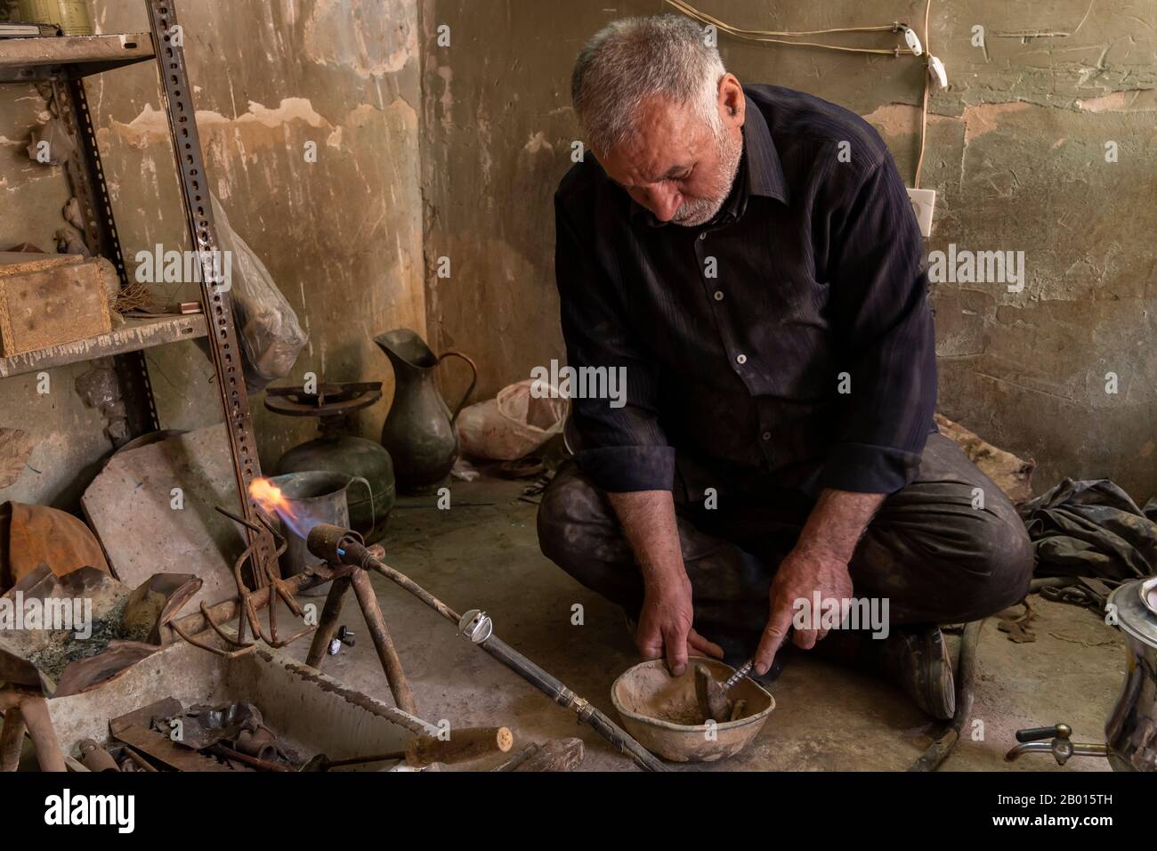 Damghan, Iran - May 25, 2019: Portait of Iranian worker in his littele ...