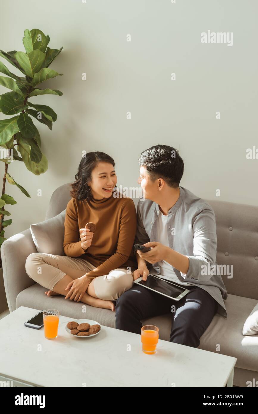 Enjoying their free time at home, watching tv Stock Photo - Alamy