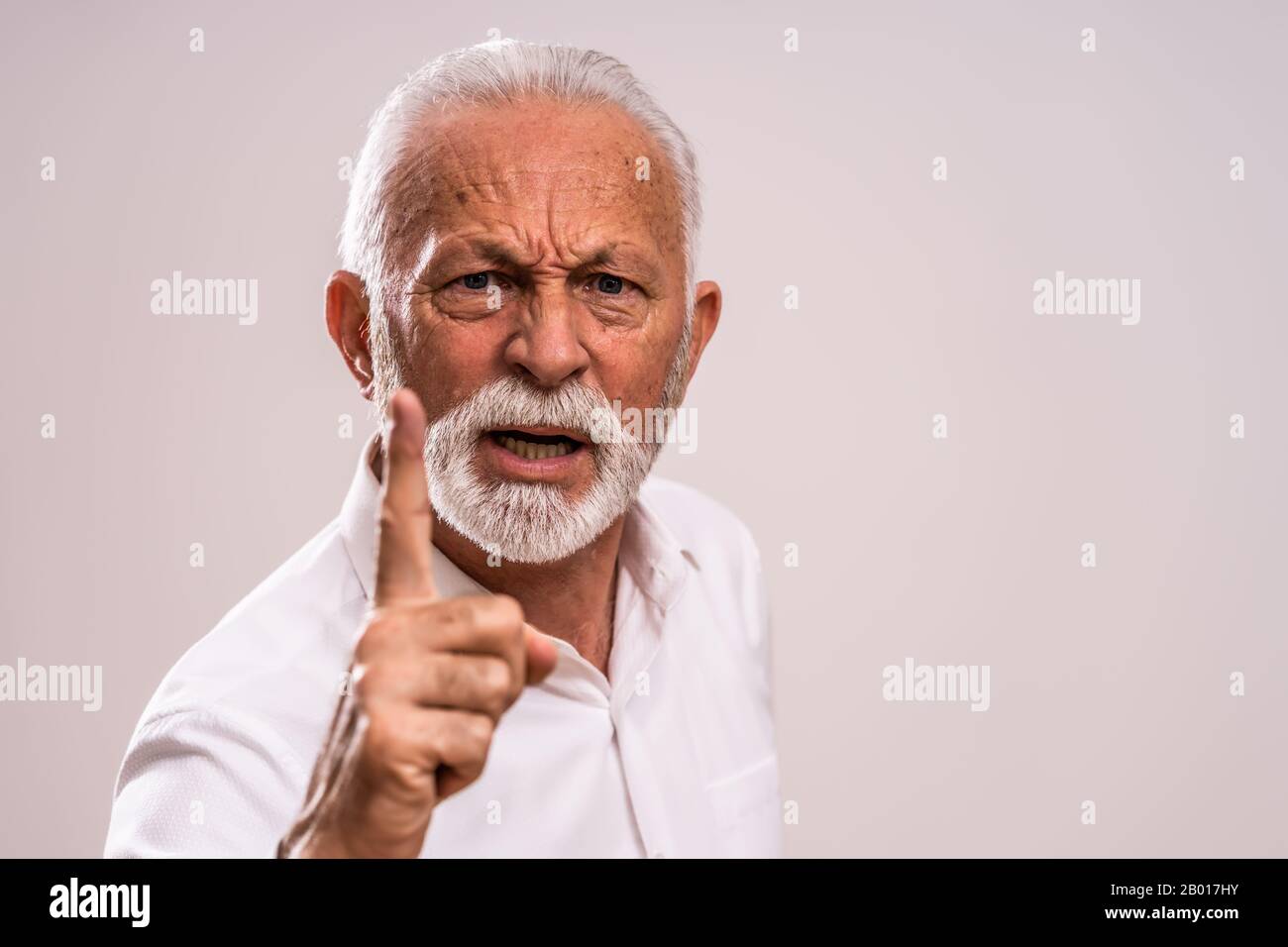 Portrait of angry senior man who threatens Stock Photo - Alamy