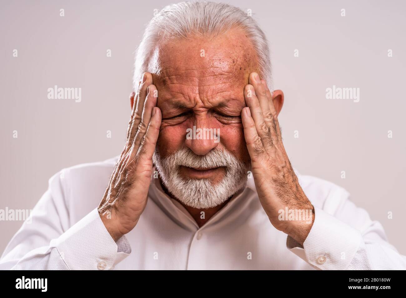 Portrait of senior man who is having headache Stock Photo - Alamy
