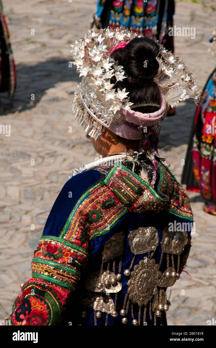 China: Elaborate headdress and costume of a Miao woman in the village ...