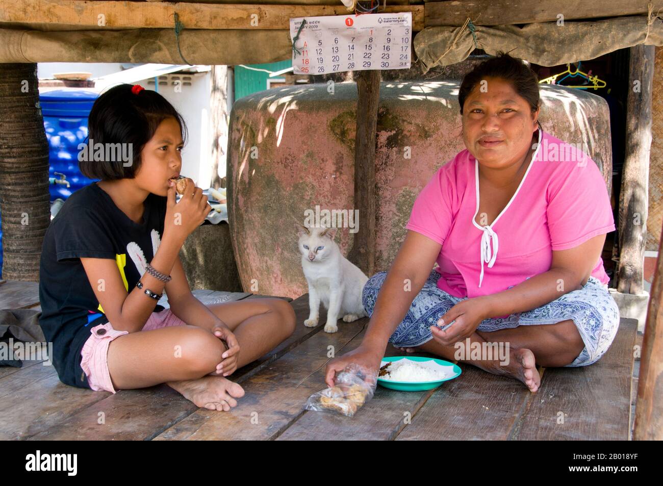 Thailand: An Urak Lawoi (Sea Gypsy) mother and daughter eat lunch, Laem ...