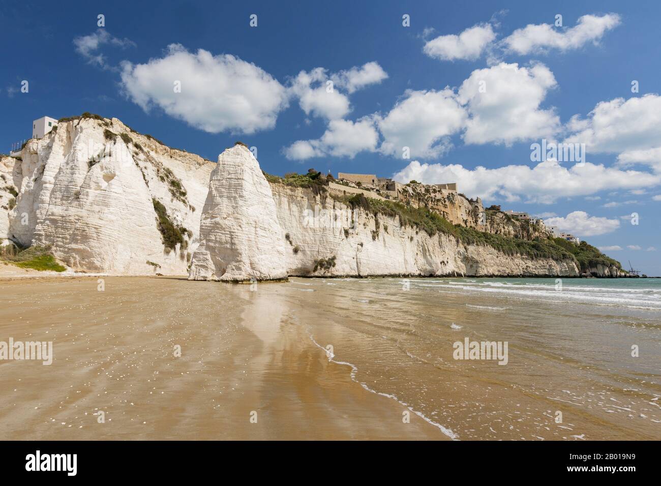 Limestone rock monolith and cliffs by the beach, Vieste, Gargano ...