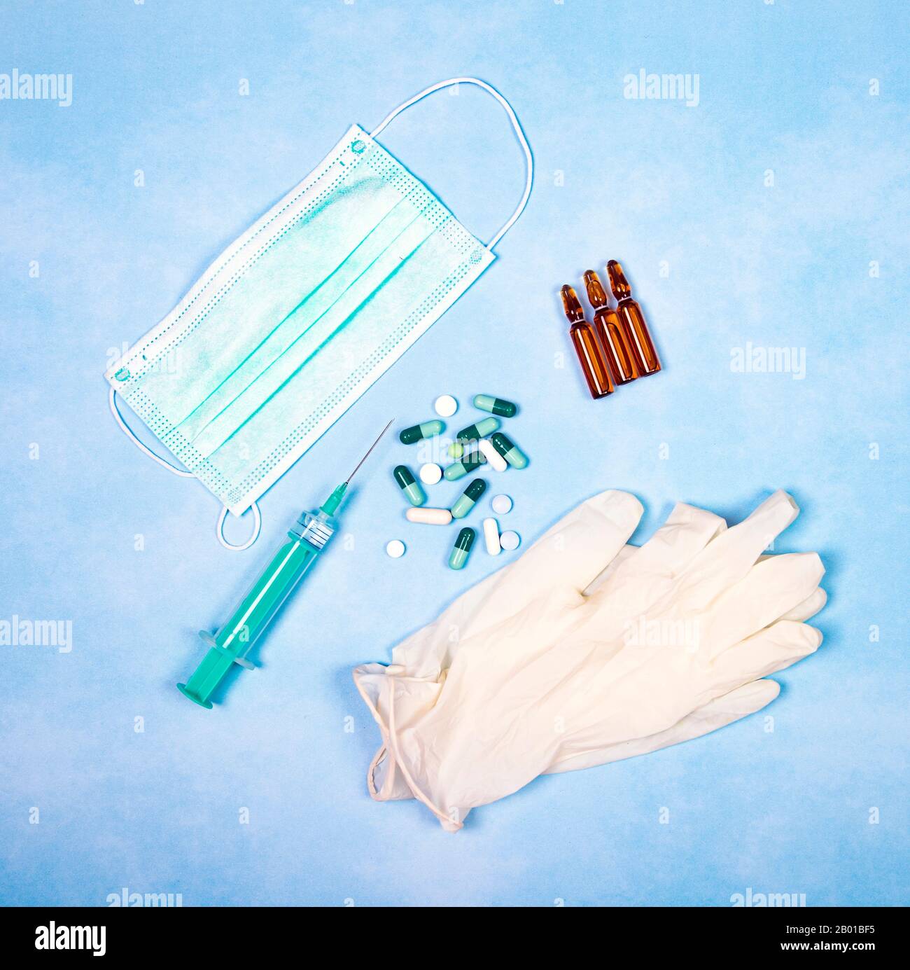 Flat-lay of medical equipment on blue background. Disease prevention ...