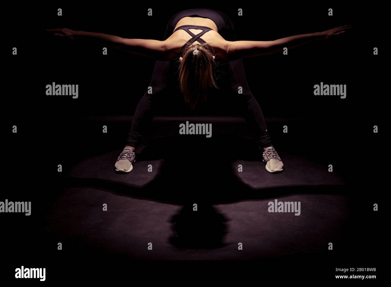 Fit female model in sport clothing doing exercises in the studio with ...