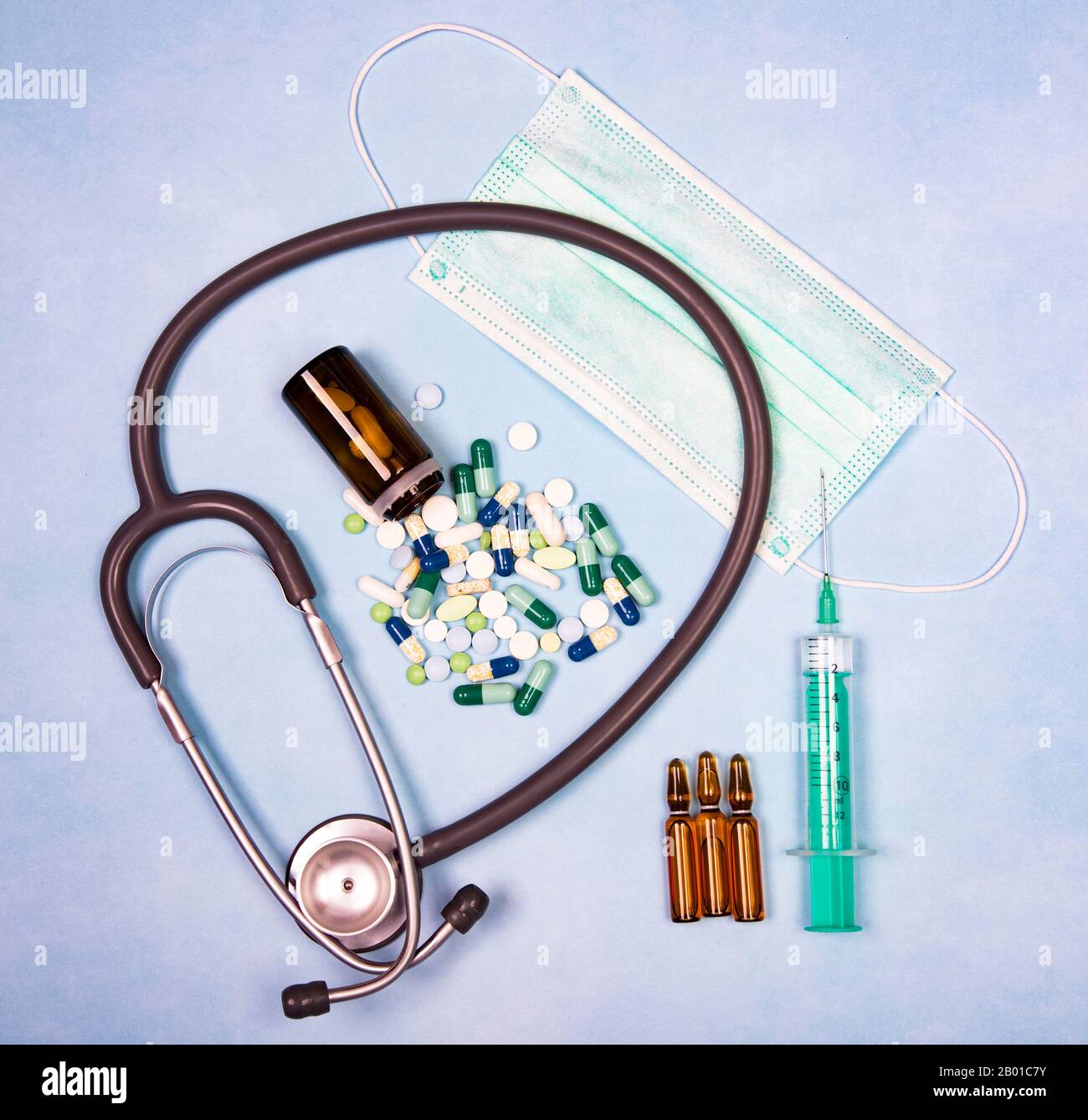 Flat-lay of medical equipment on blue background. Disease prevention ...