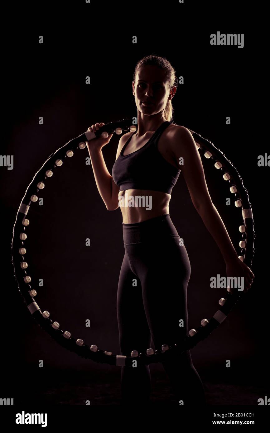 Fit female model in sport clothing doing exercises in the studio with ...