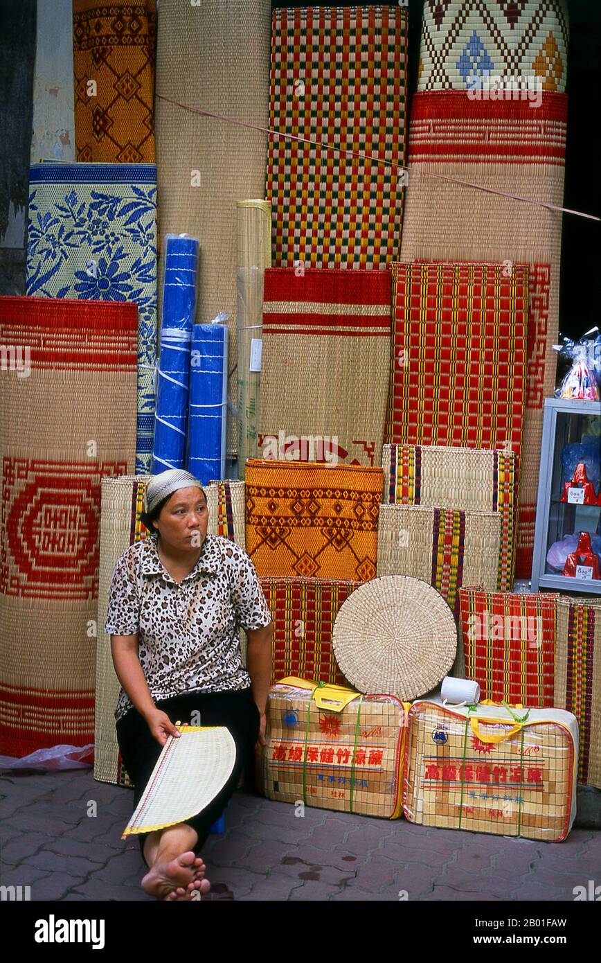 Vietnam: A mat seller waiting for customers in the Old Quarter, Hanoi ...