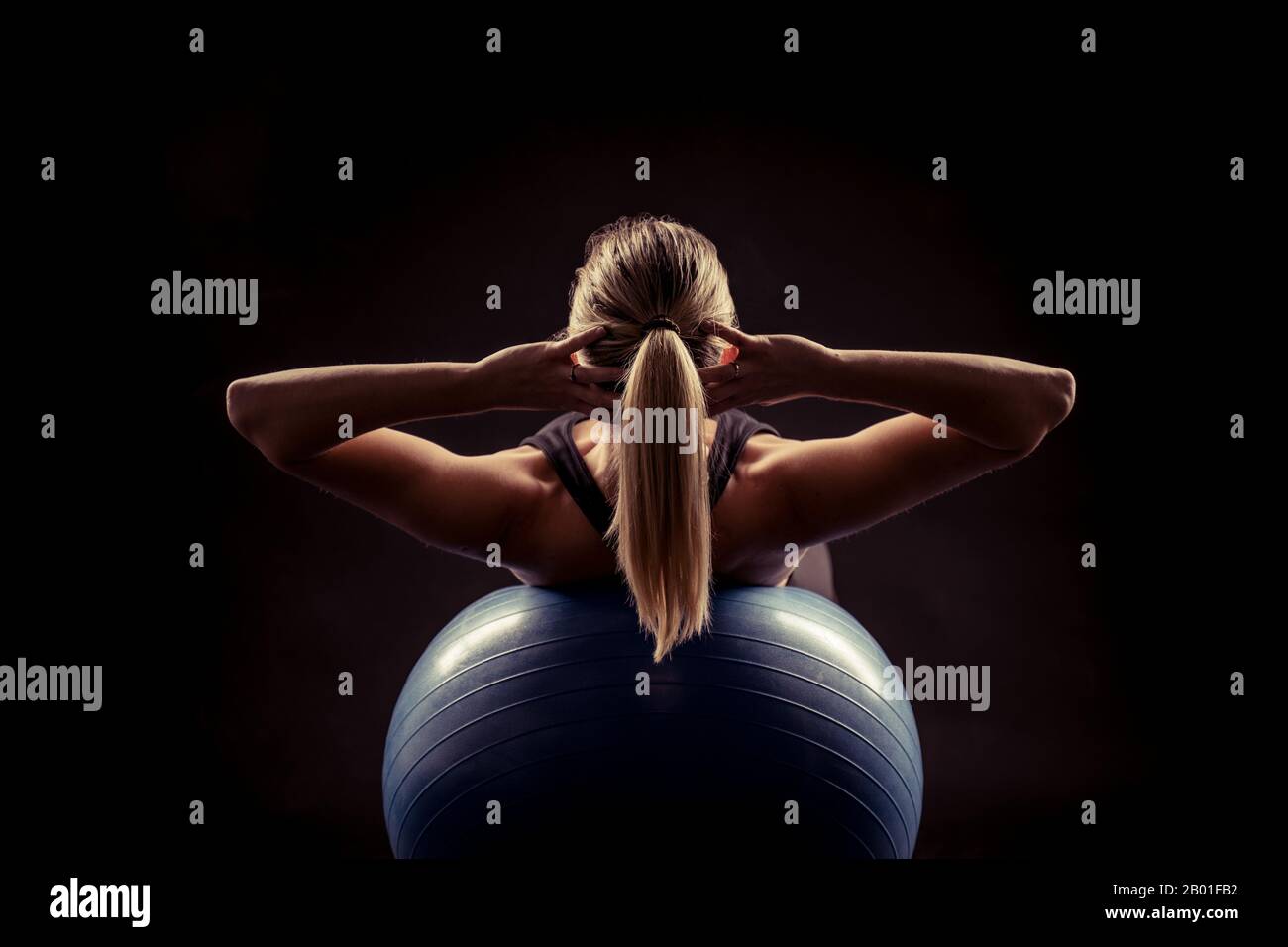 Fit female model in sport clothing doing exercises in the studio with ...