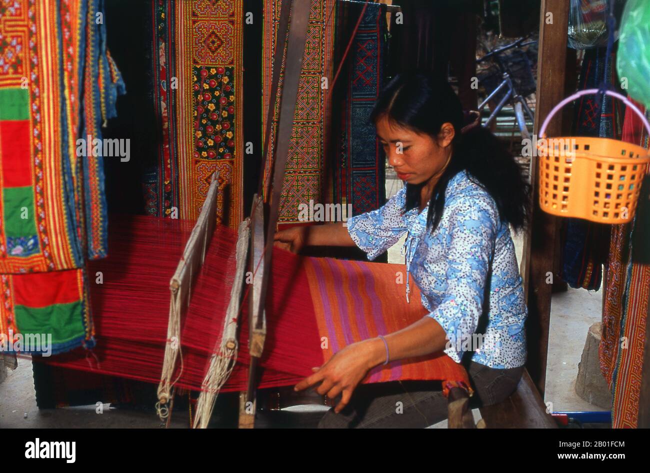 Vietnam: White Tai weaver, Mai Chau, Hoa Binh Province. In the narrow ...