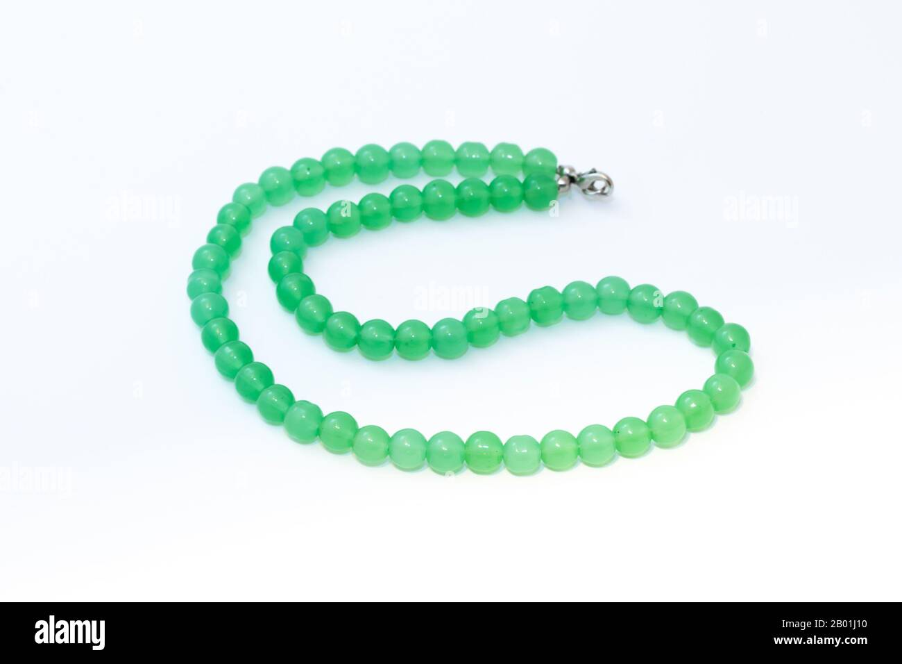 Green nephritis beads isolated on white background Stock Photo - Alamy