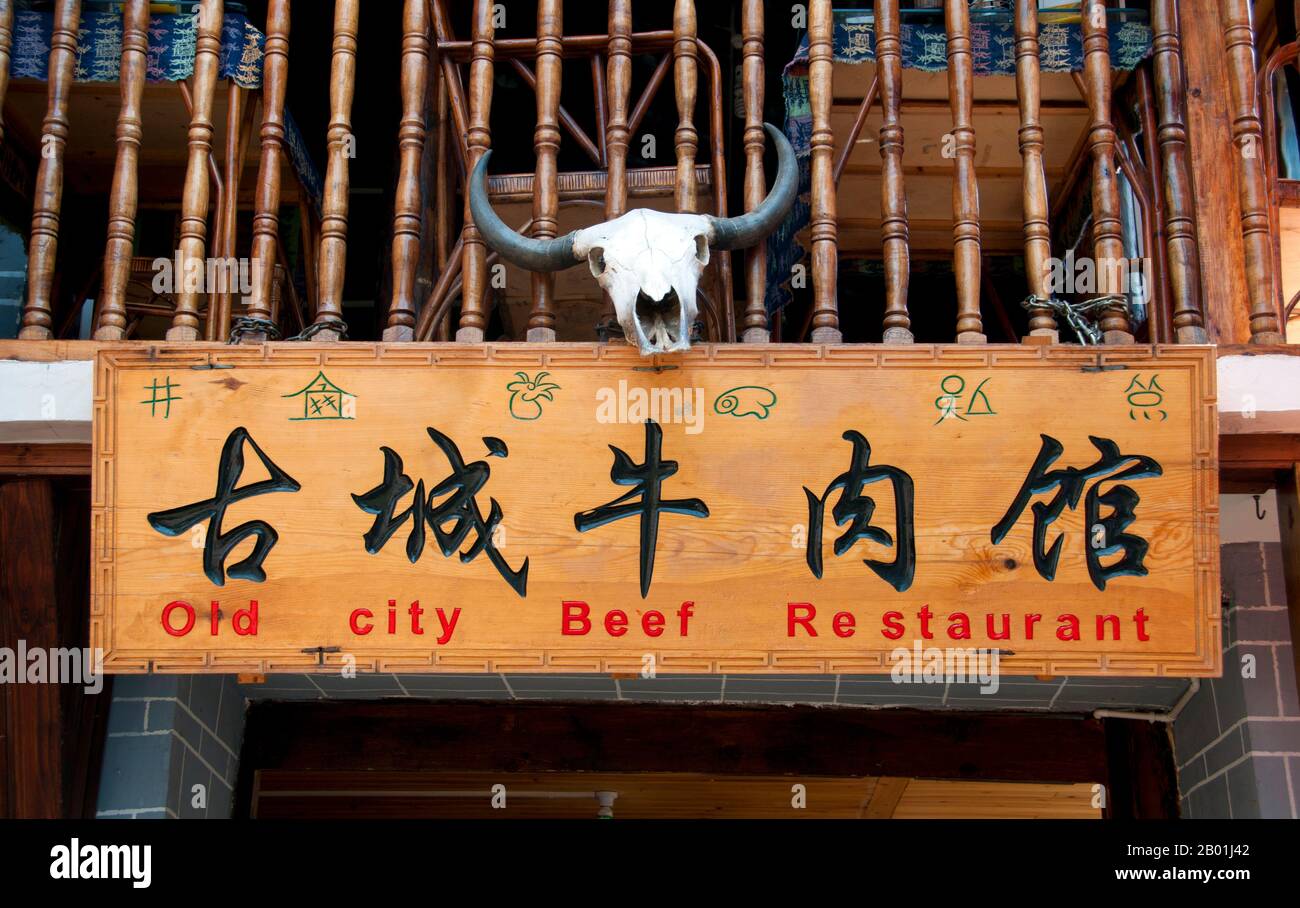 China: Restaurant sign displaying both Naxi (Dongba) and Chinese script ...