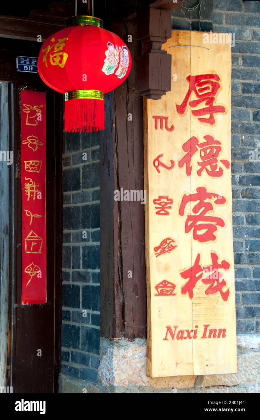 China: Hotel sign displaying both Naxi (Dongba) and Chinese script ...