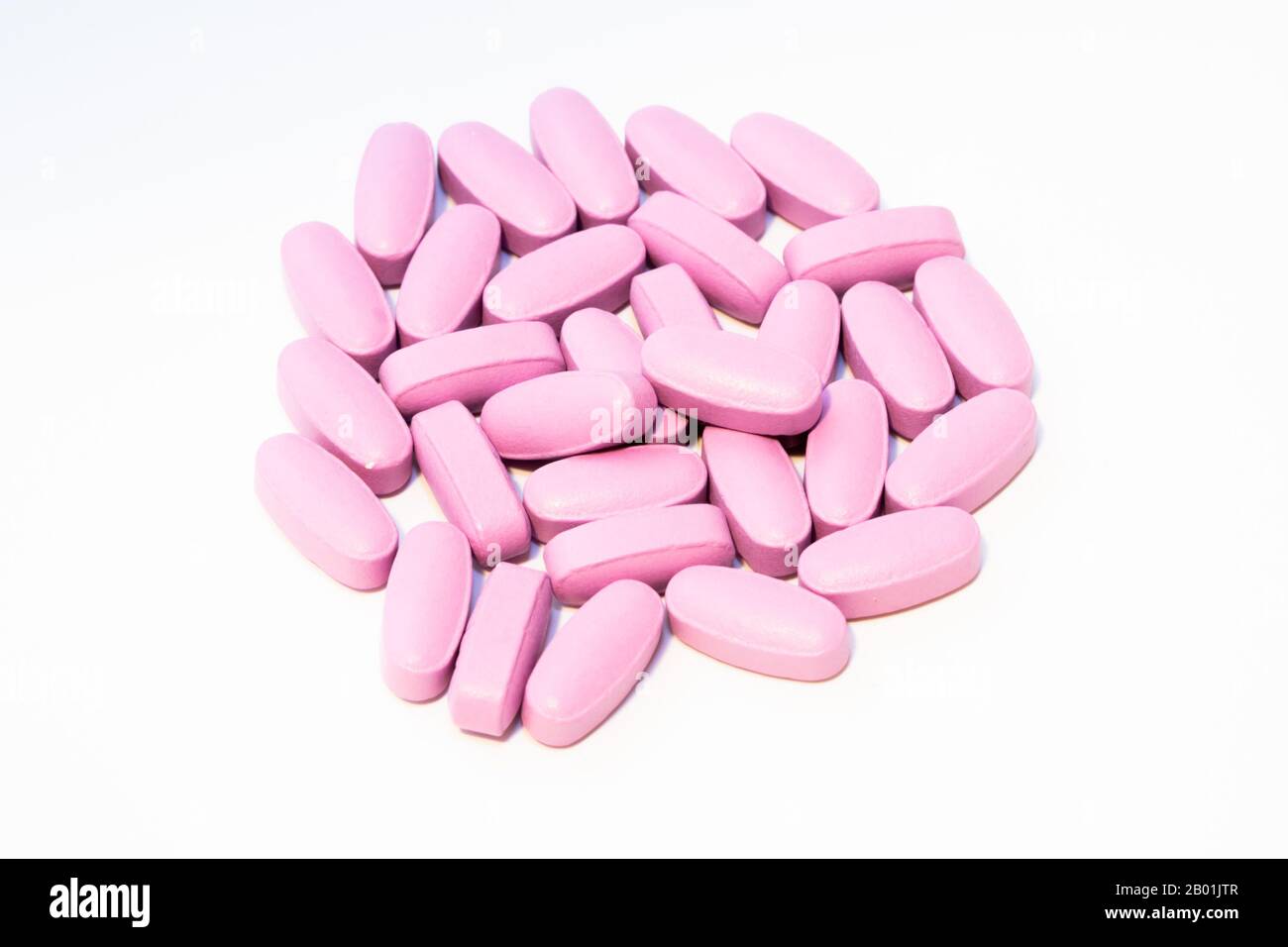 Pink vitamin pills isolated on white background Stock Photo - Alamy