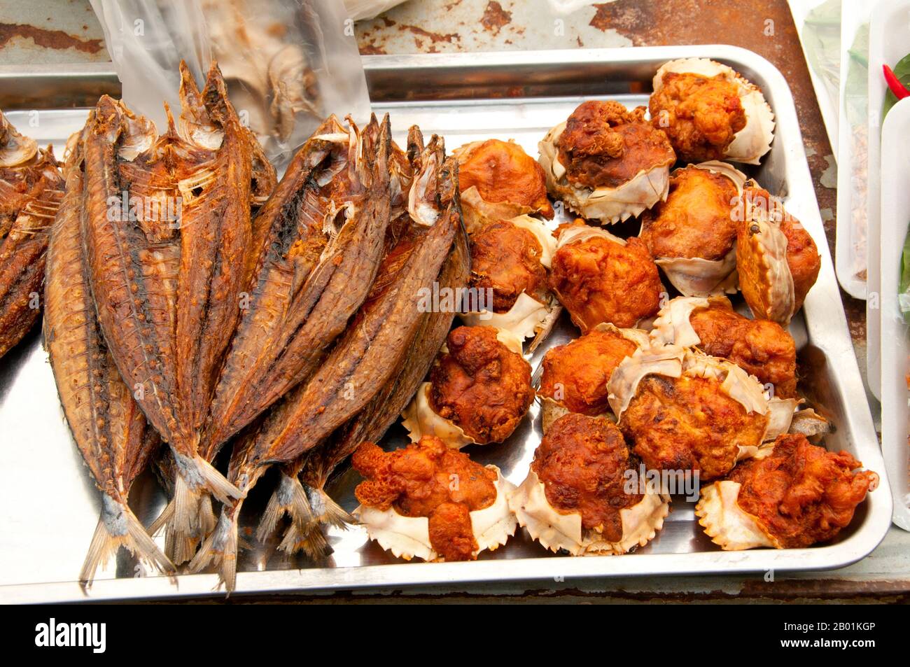 Thailand: Stuffed crab shells and dried fish in evening market behind ...