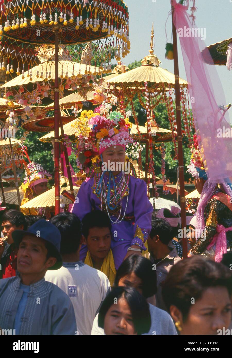 Thailand: A 'Crystal Son' sits atop a relative's shoulders and awaits ...
