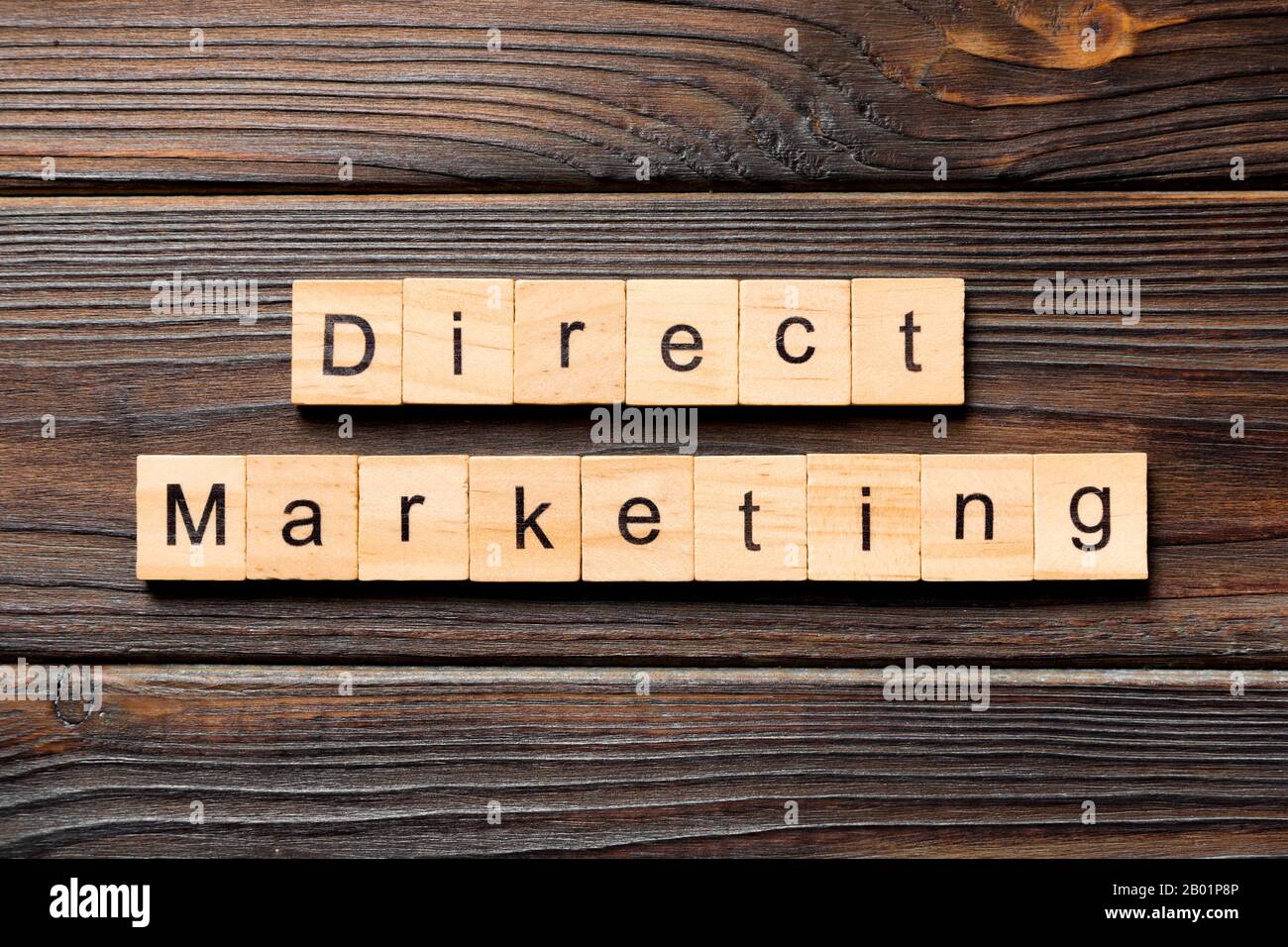 Direct marketing word written on wood block. Direct marketing text on ...